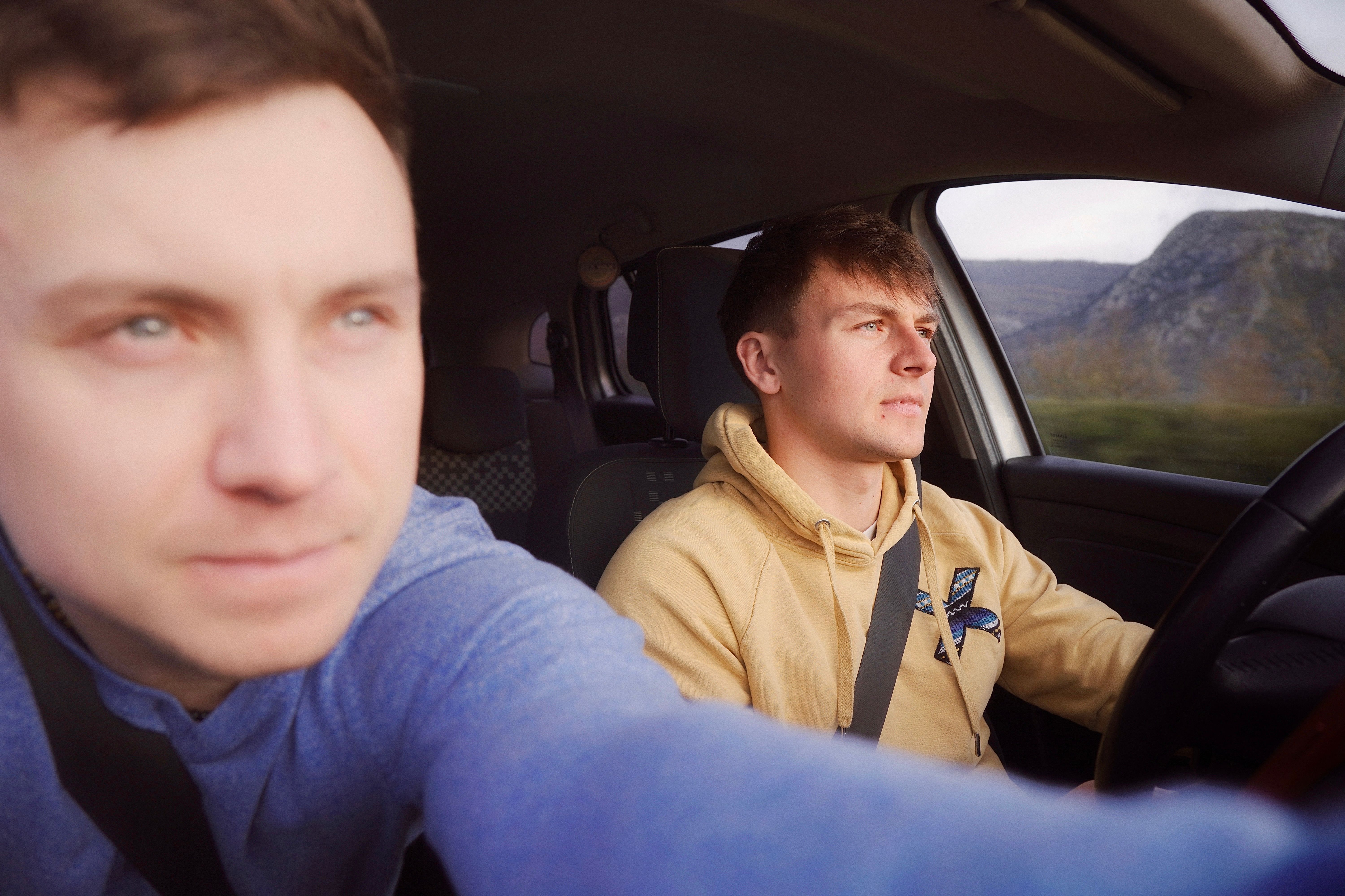 Two men are driving in a car together · Free Stock Photo