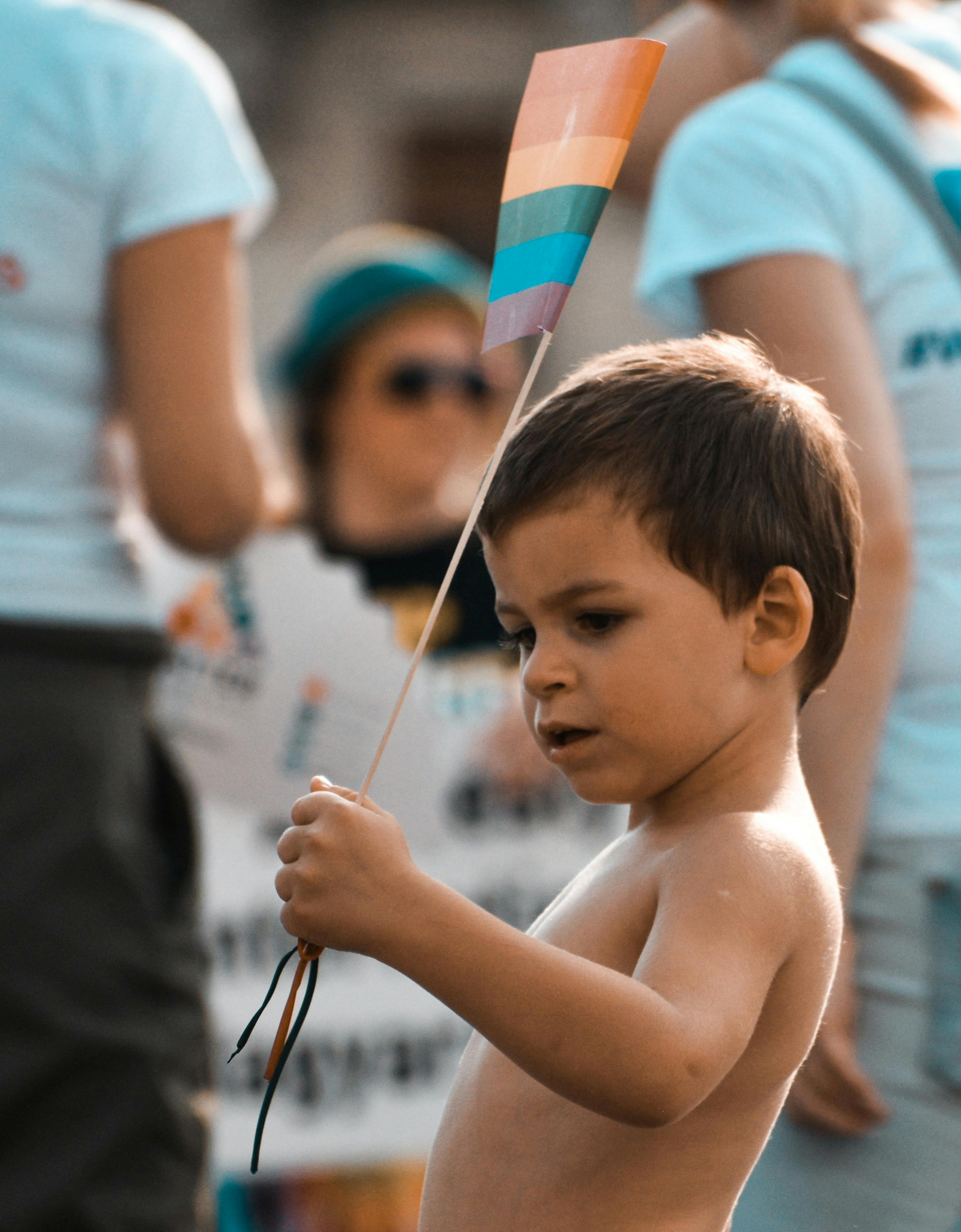 Boy Holding Rainbow Flag · Free Stock Photo