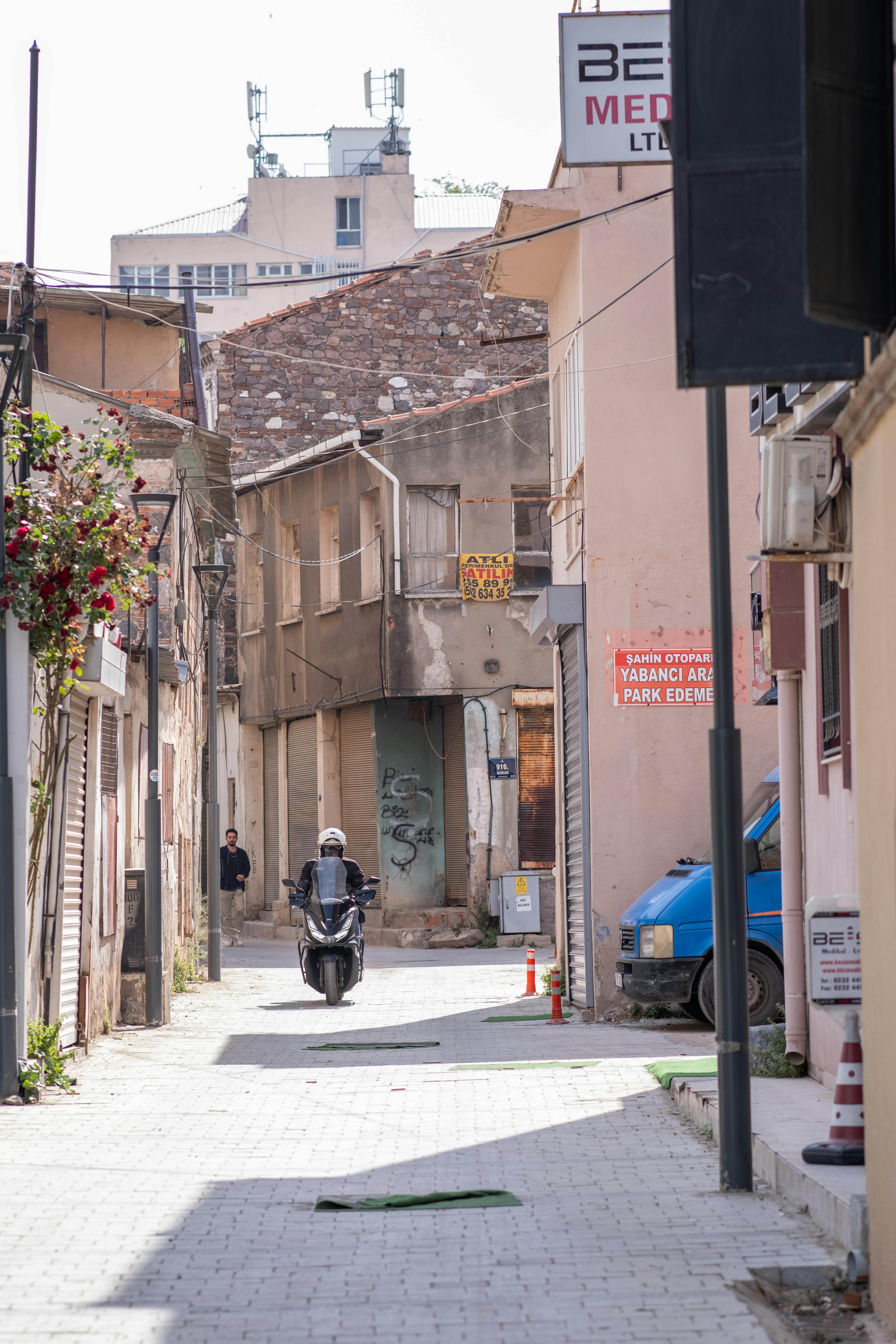 Person Riding Motorcycle in an Alley · Free Stock Photo