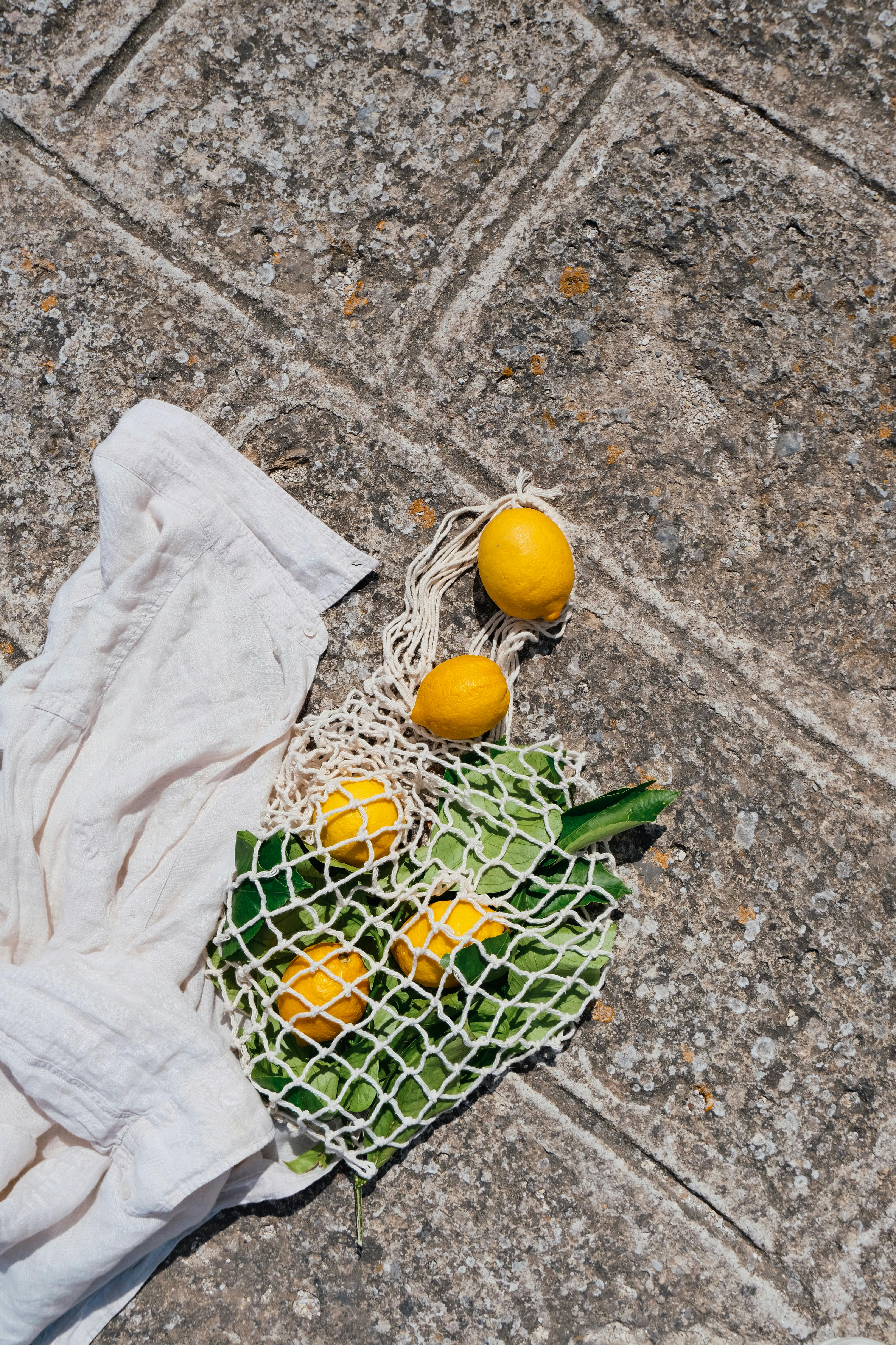 Torn Bag with Lemons on Pavement · Free Stock Photo