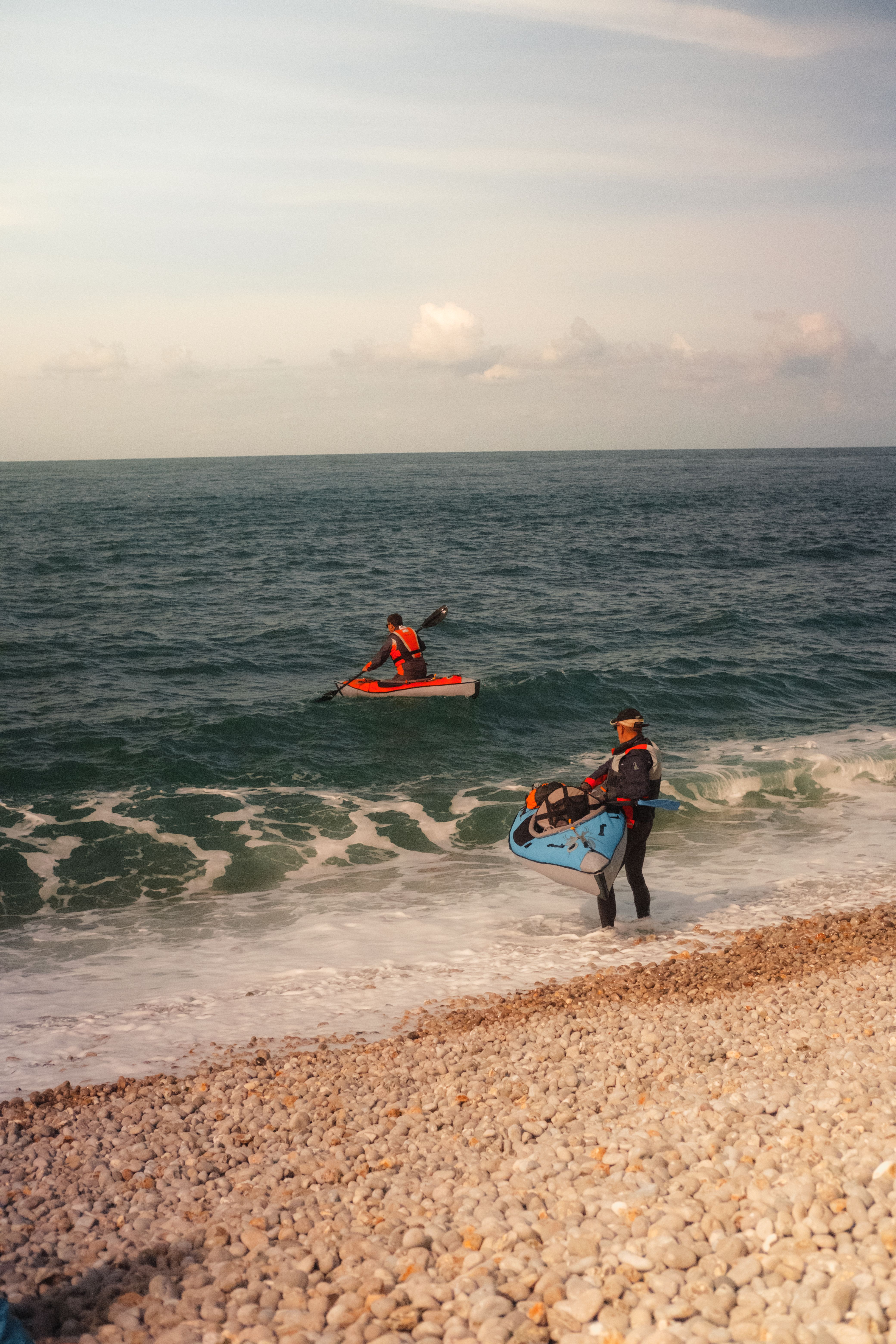 Men Canoeing on Sea Shore · Free Stock Photo