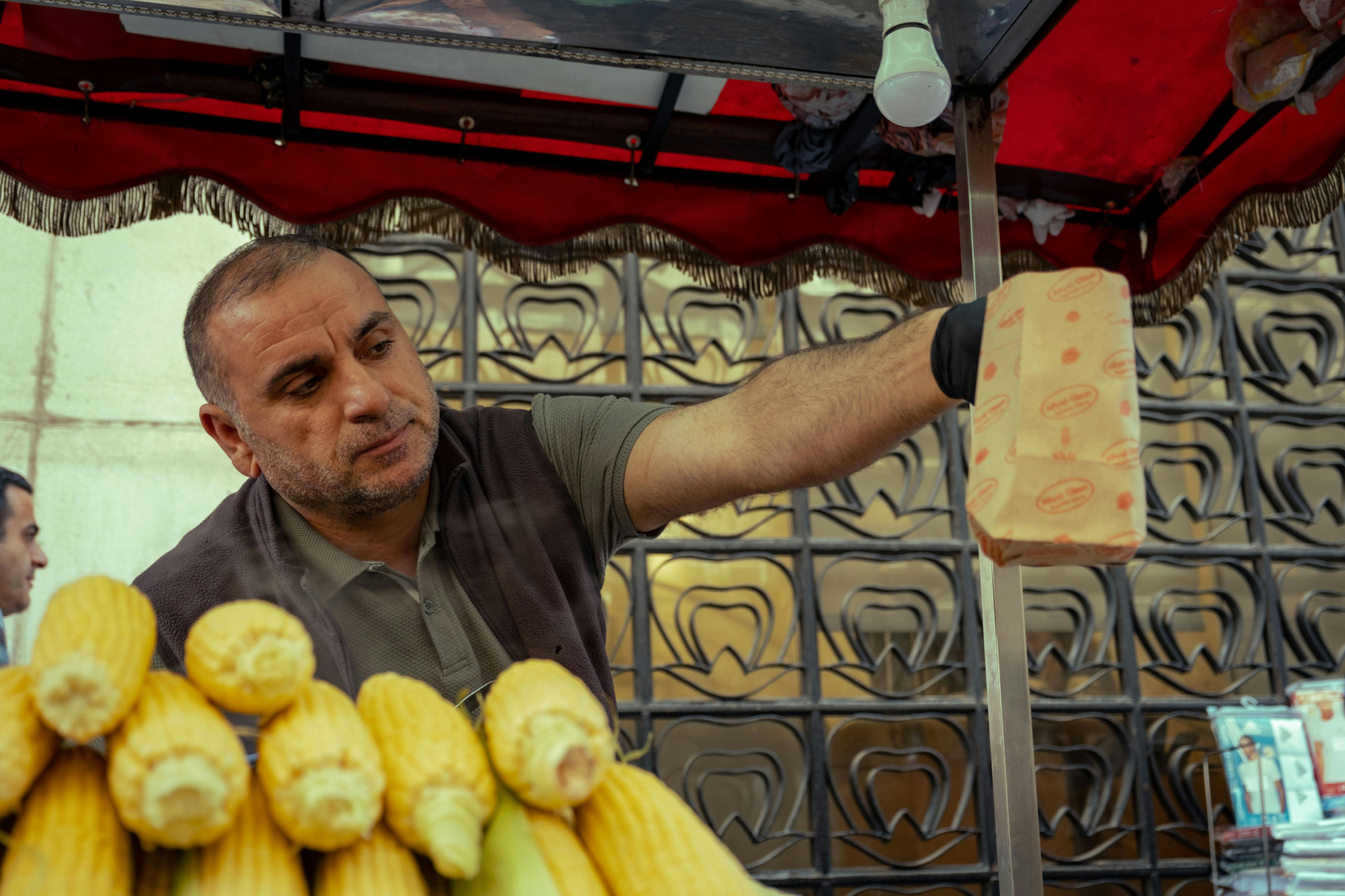 Man Selling Corn on a Market · Free Stock Photo