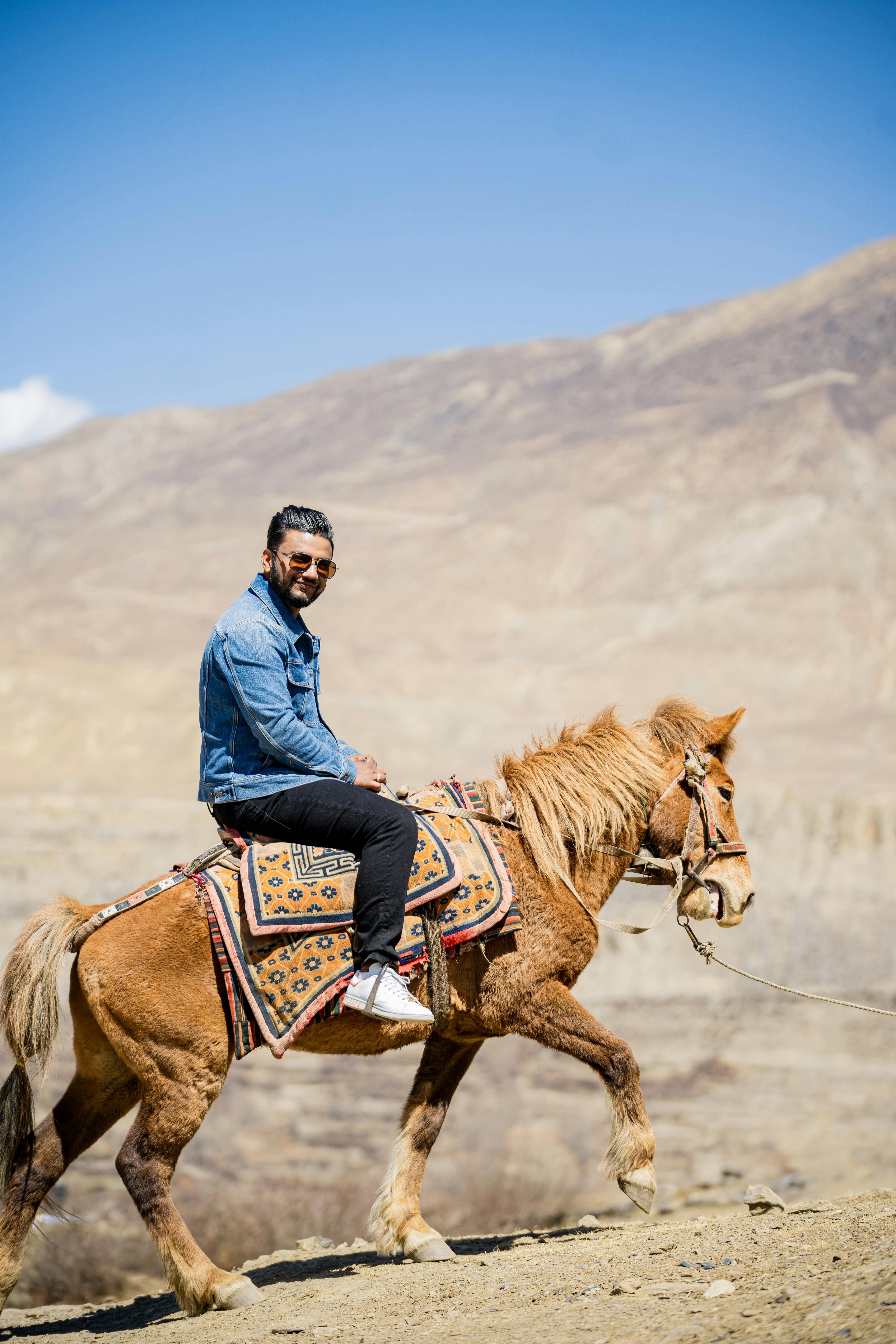 Man Horseback Riding on Desert · Free Stock Photo