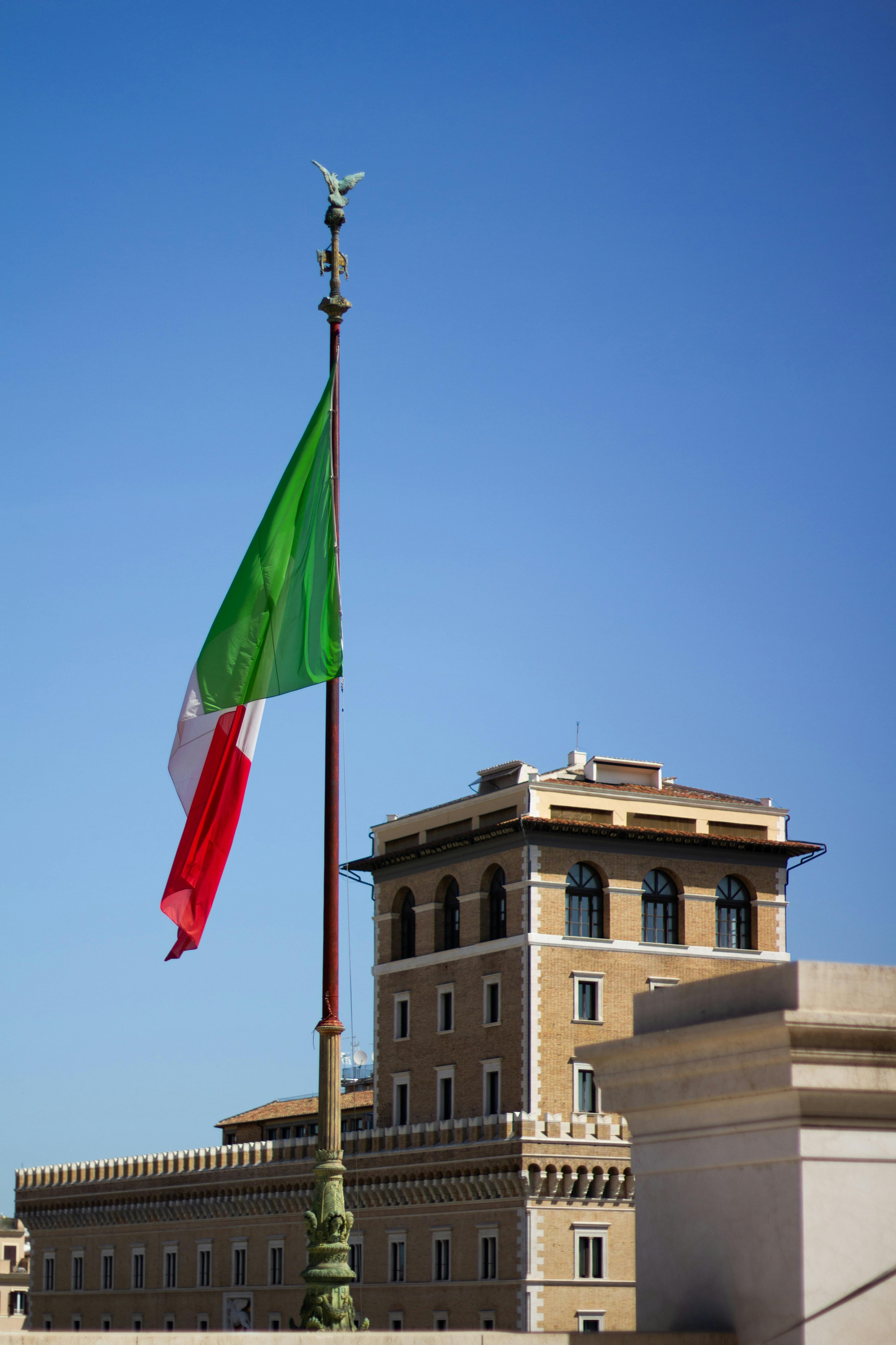Flag of Italy near Building with Tower · Free Stock Photo