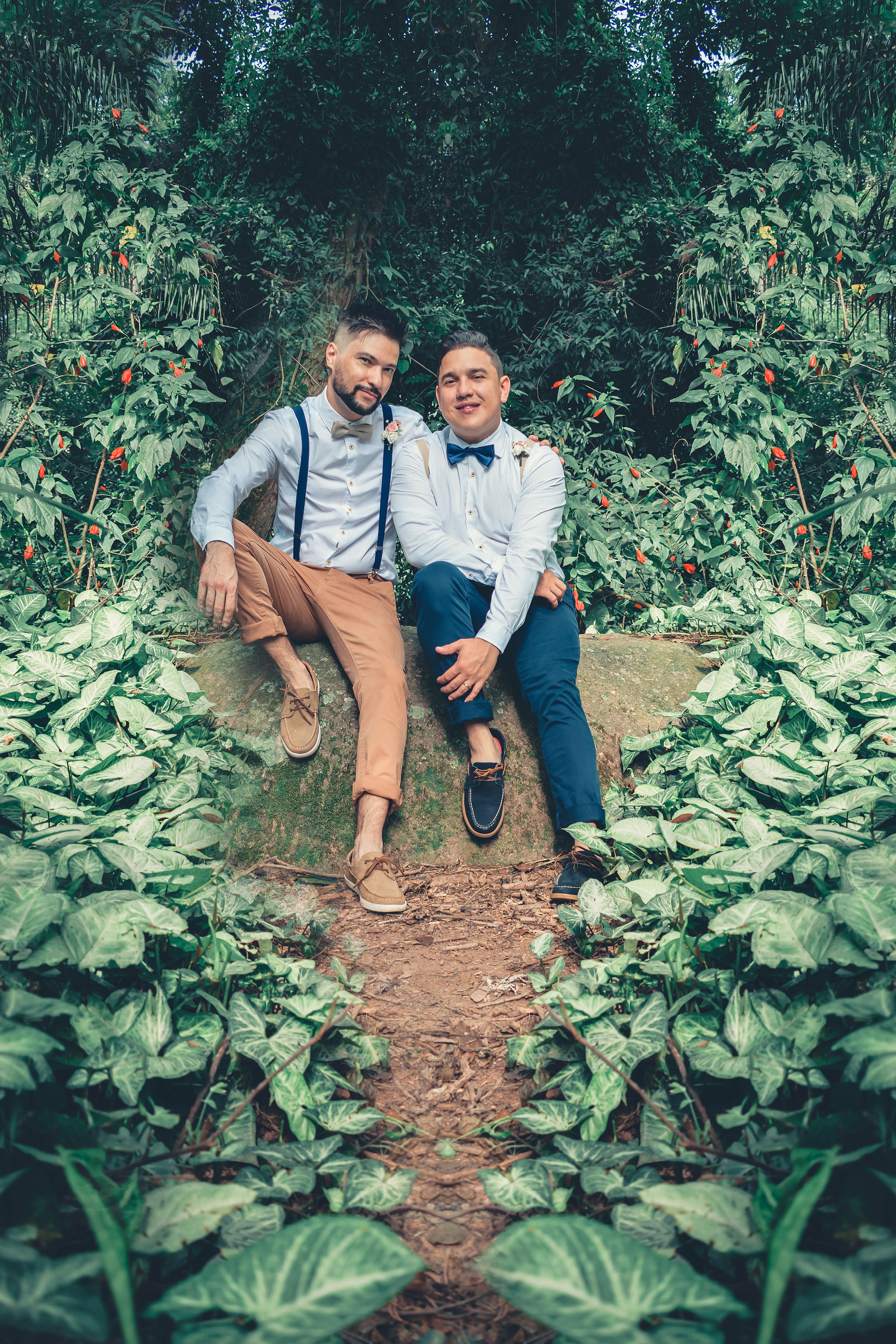 Two Man Wearing Pants Sitting Besides Green Plants · Free Stock Photo