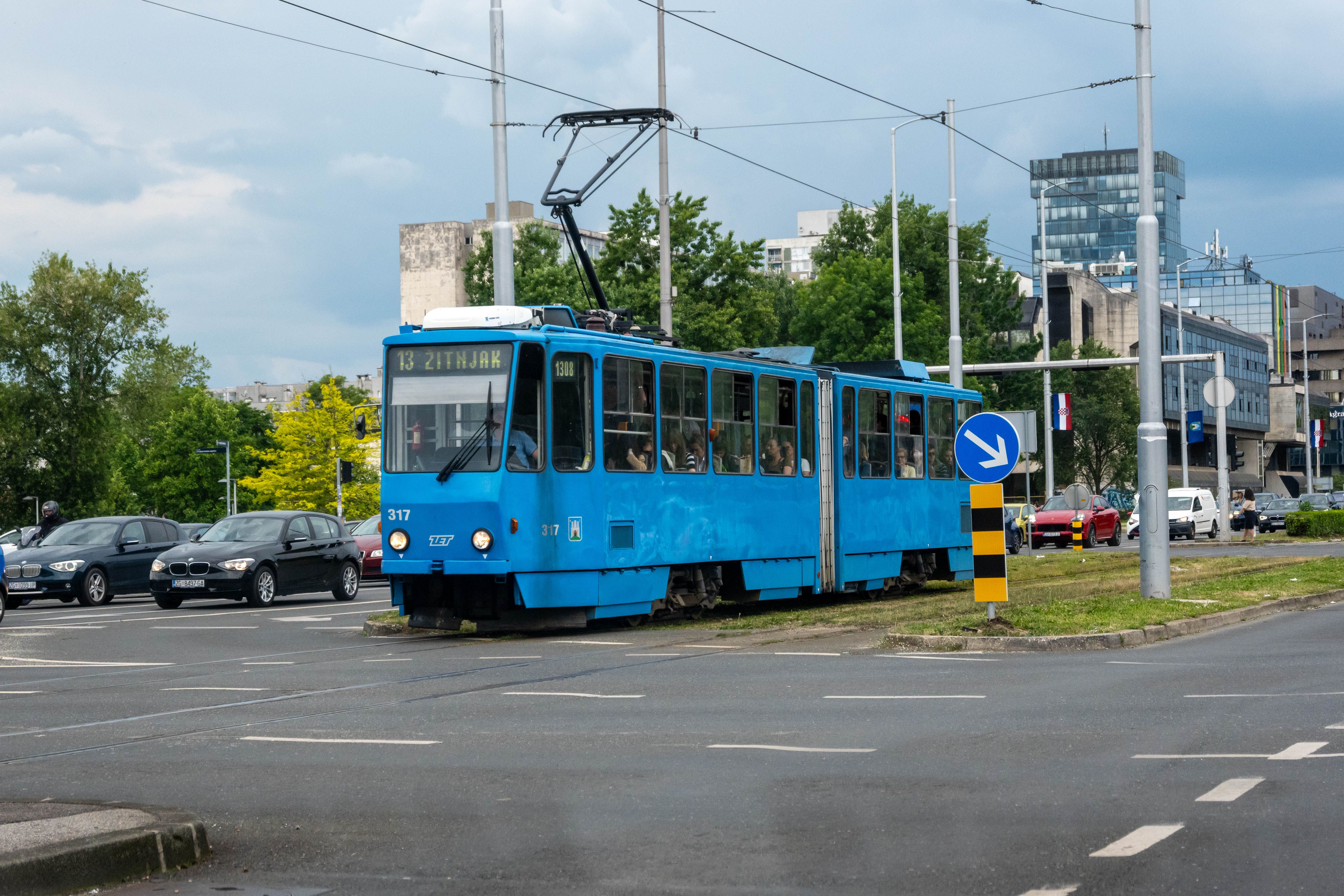 A blue tram on the street · Free Stock Photo