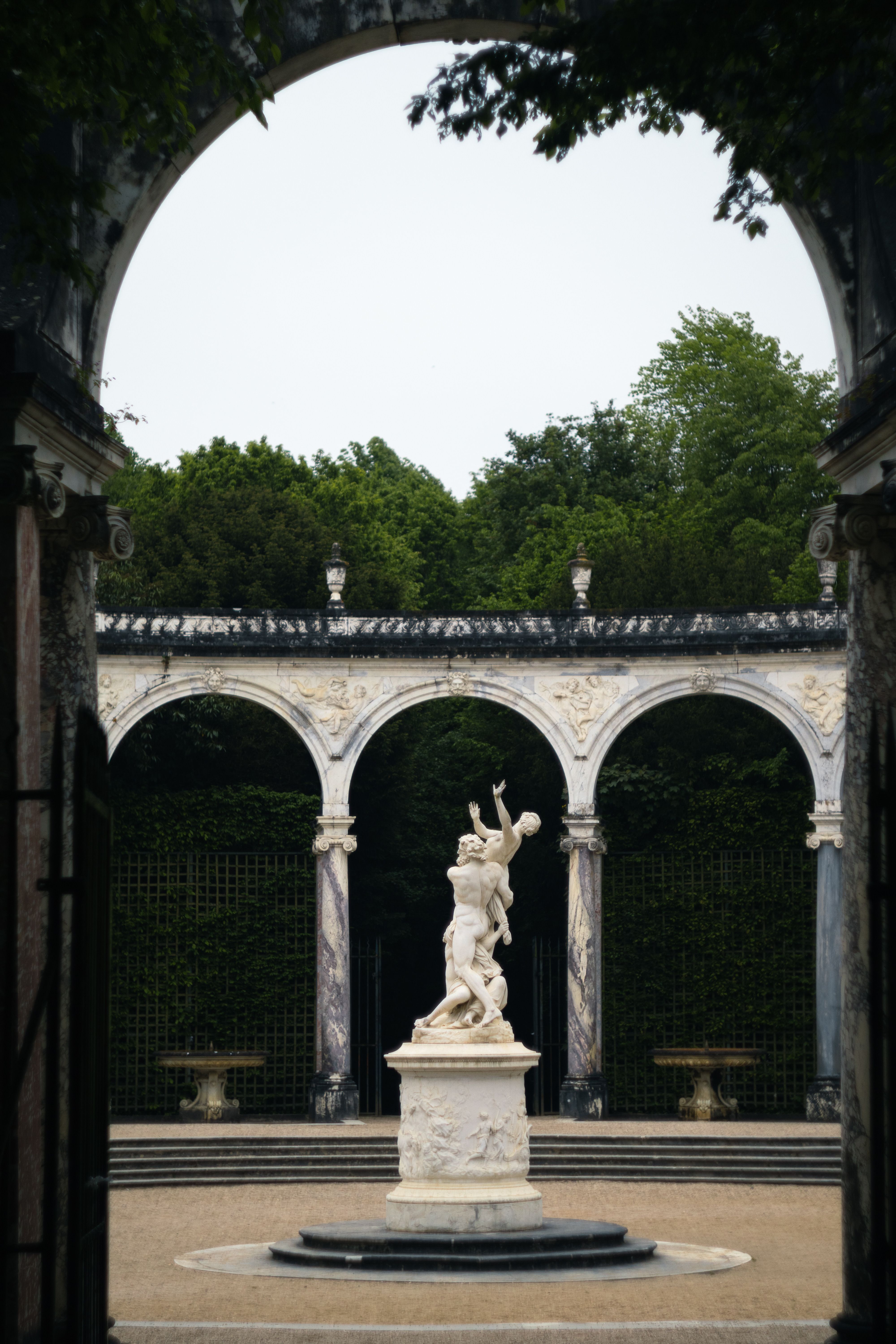Marble Statue Among Arches · Free Stock Photo