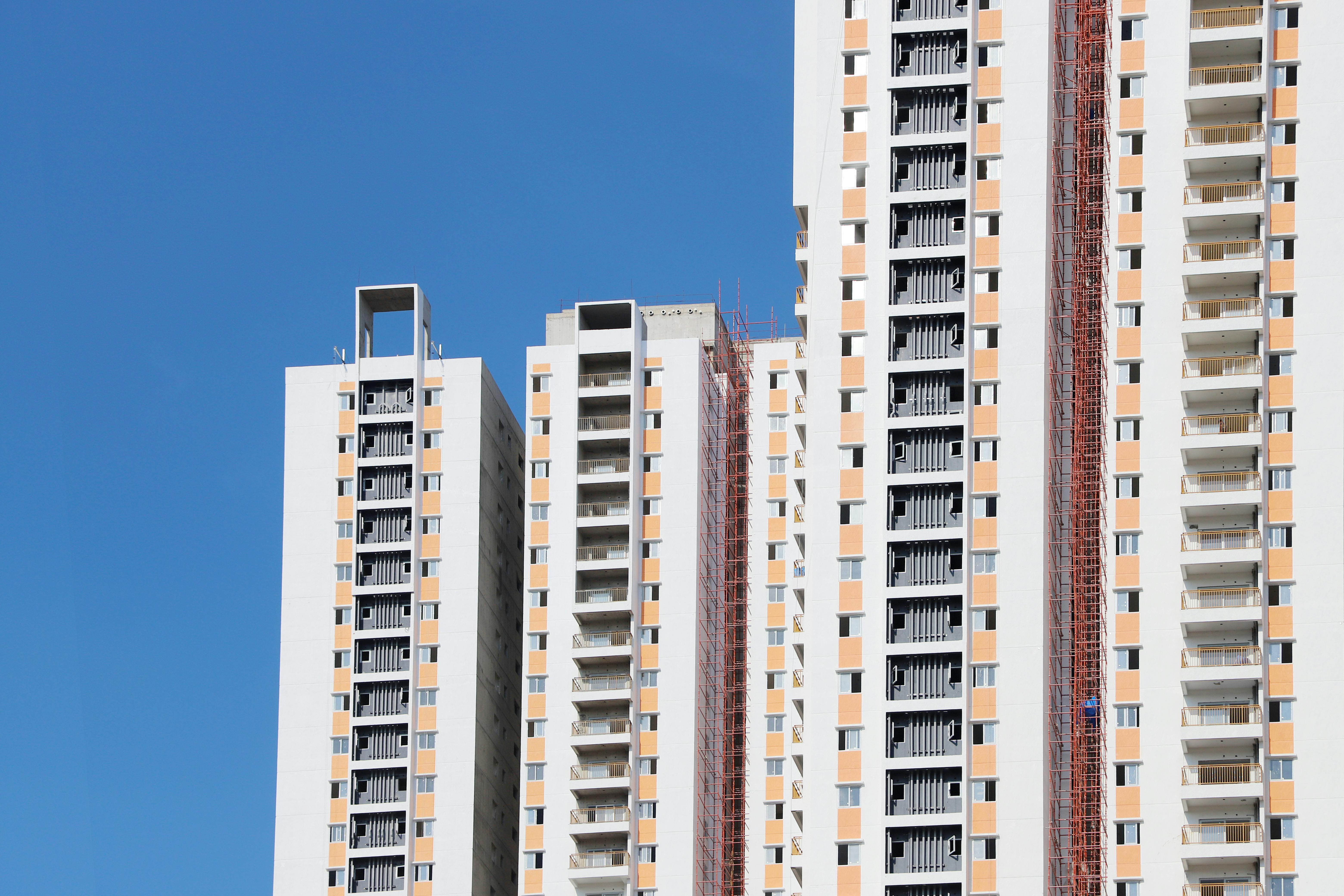 A group of tall apartment buildings with windows · Free Stock Photo