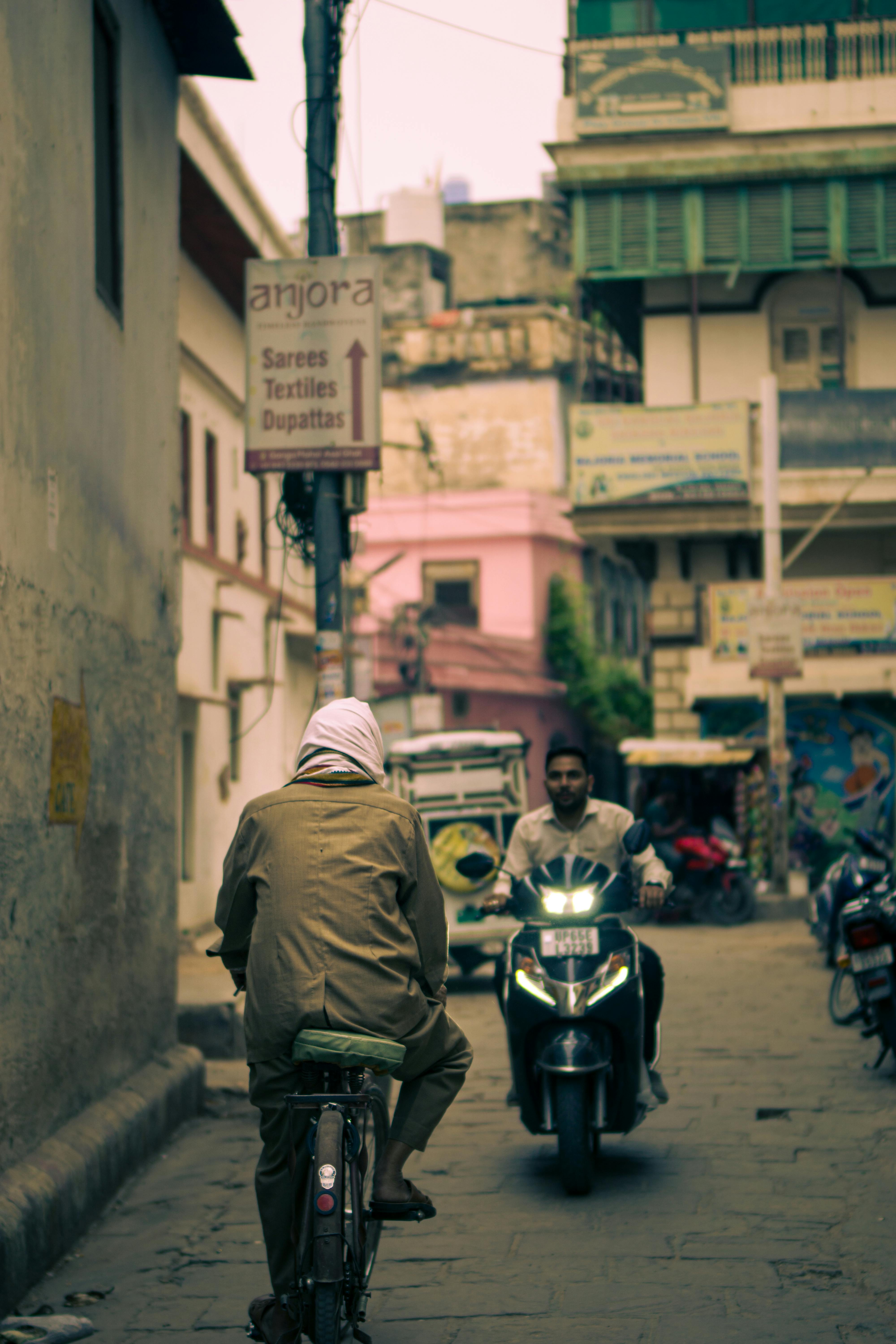 View of People Riding Motor Scooters on a Street · Free Stock Photo