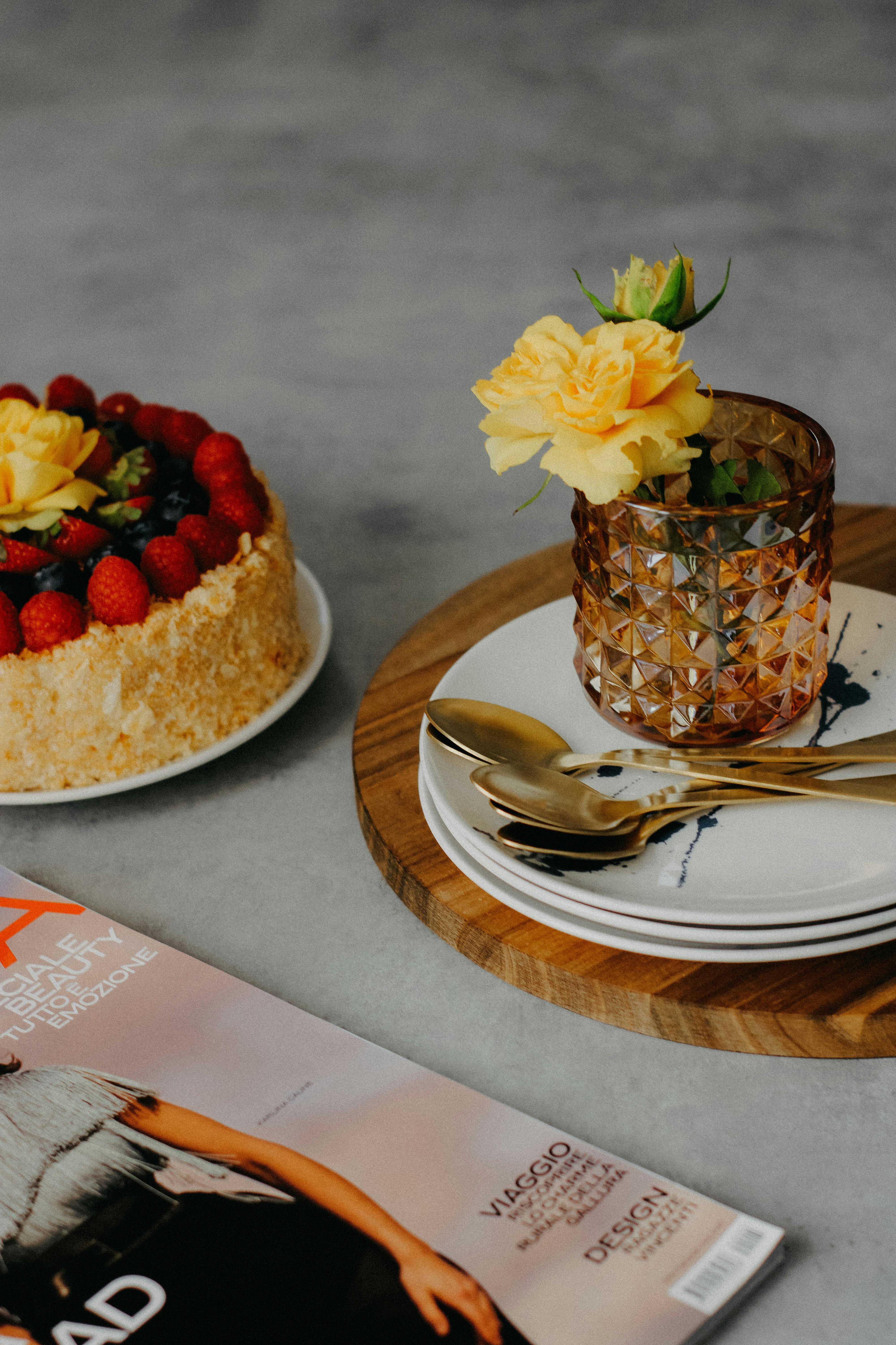 Spoons on a Stack of Plates Next to the Cake and the Magazine · Free ...
