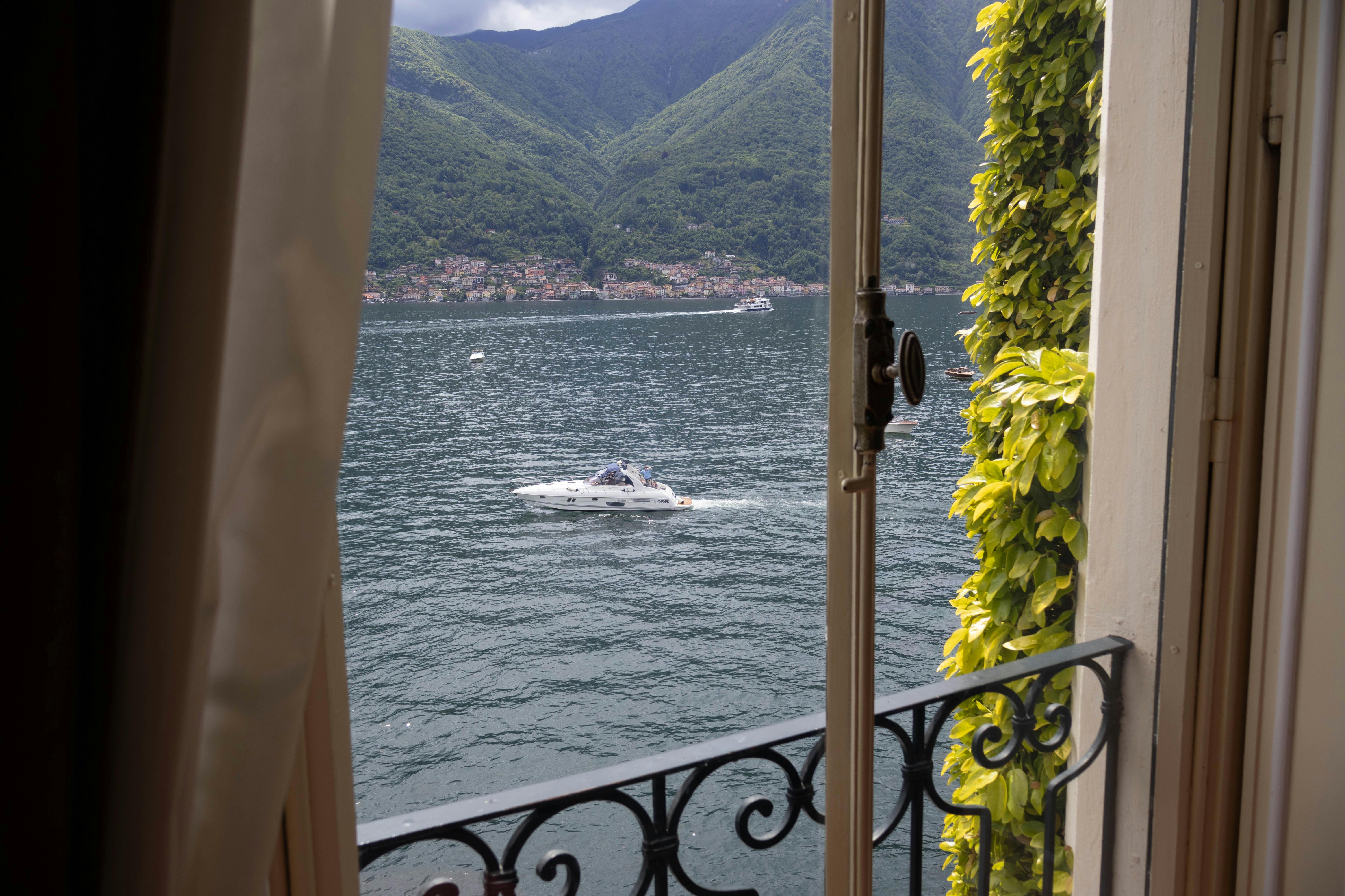 Motorboat on Lake Como behind Window · Free Stock Photo