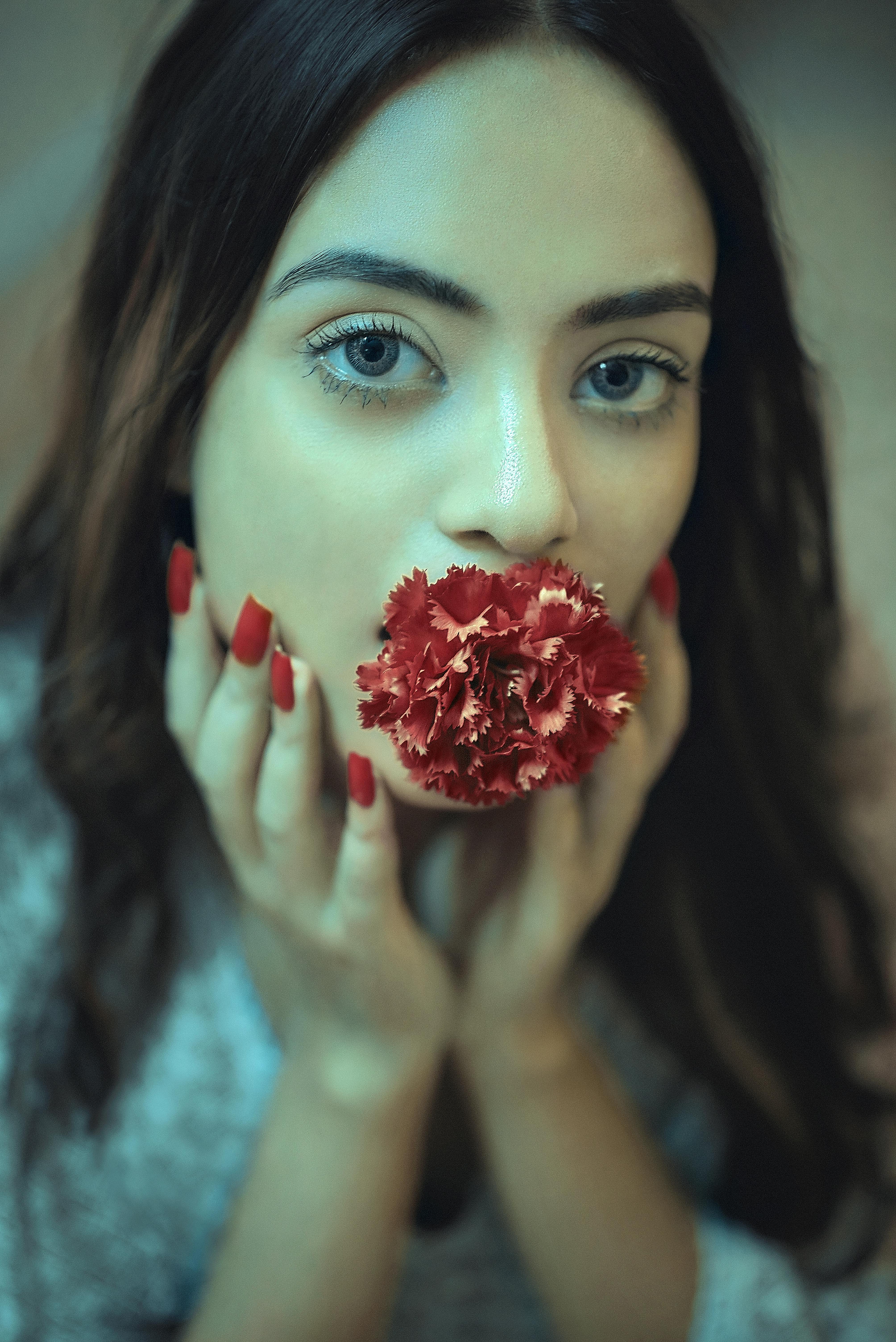 Woman Biting Red Petaled Flower · Free Stock Photo