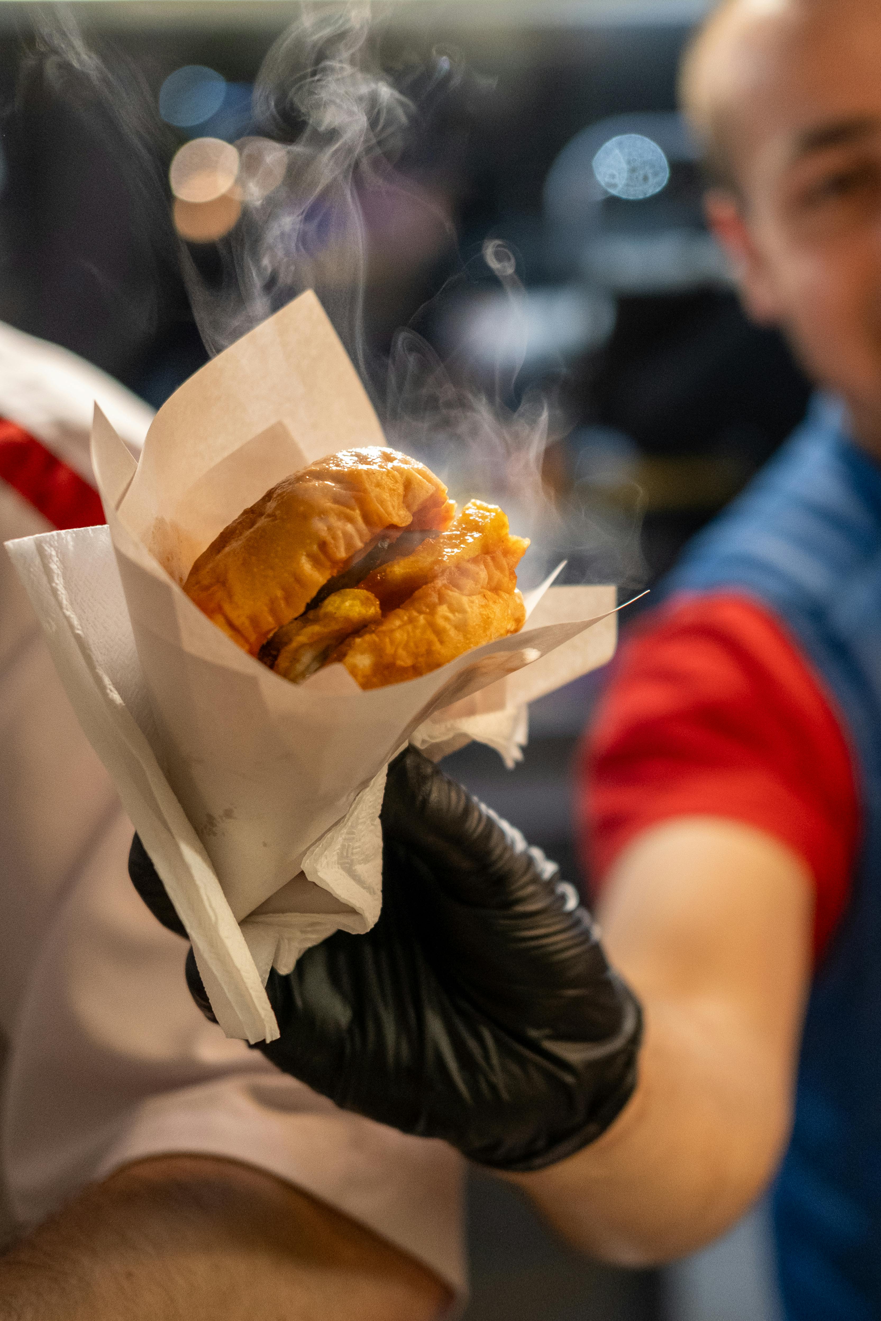 Steaming Burger in Hand of Chef · Free Stock Photo