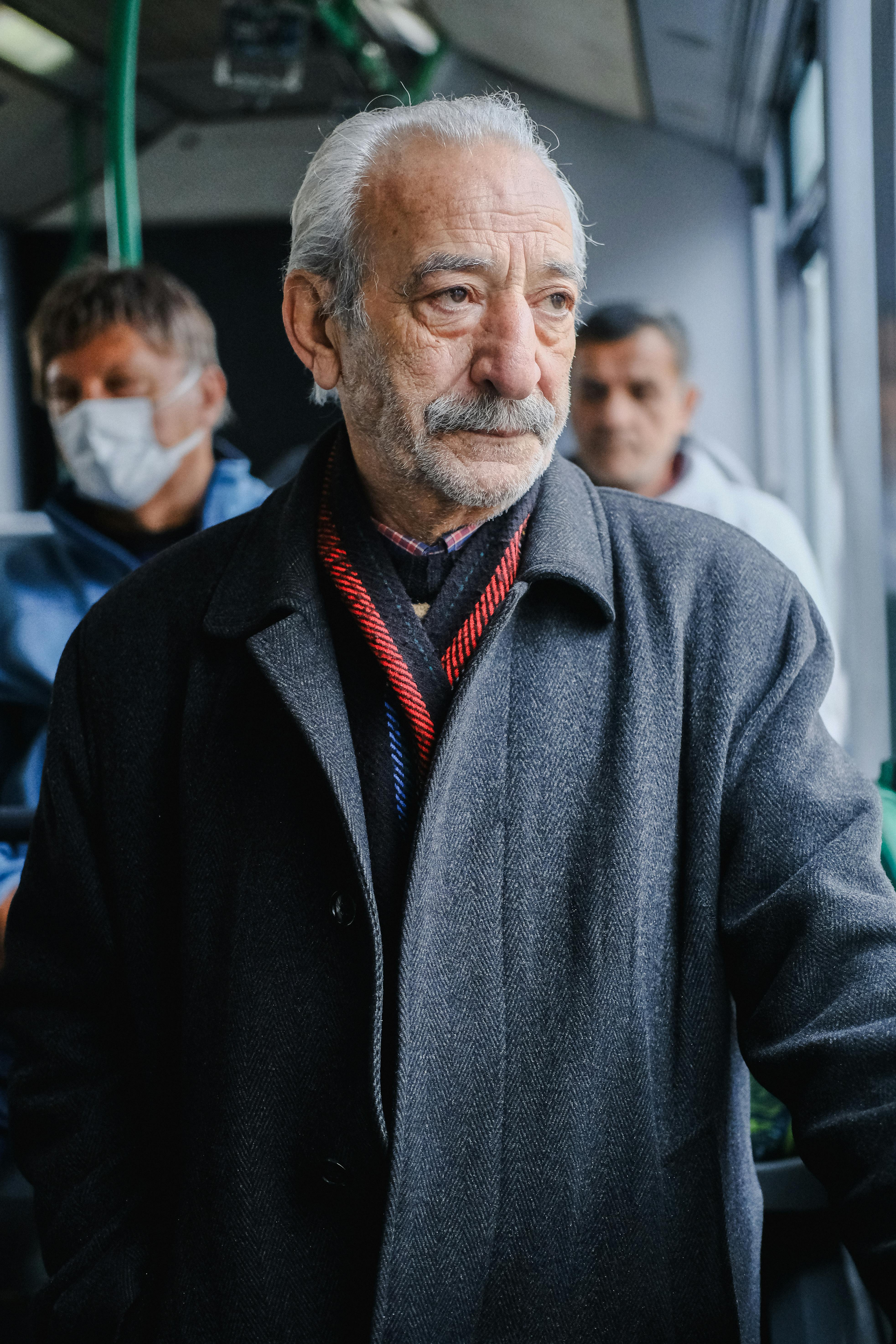 Thoughtful Old Man on the Bus · Free Stock Photo
