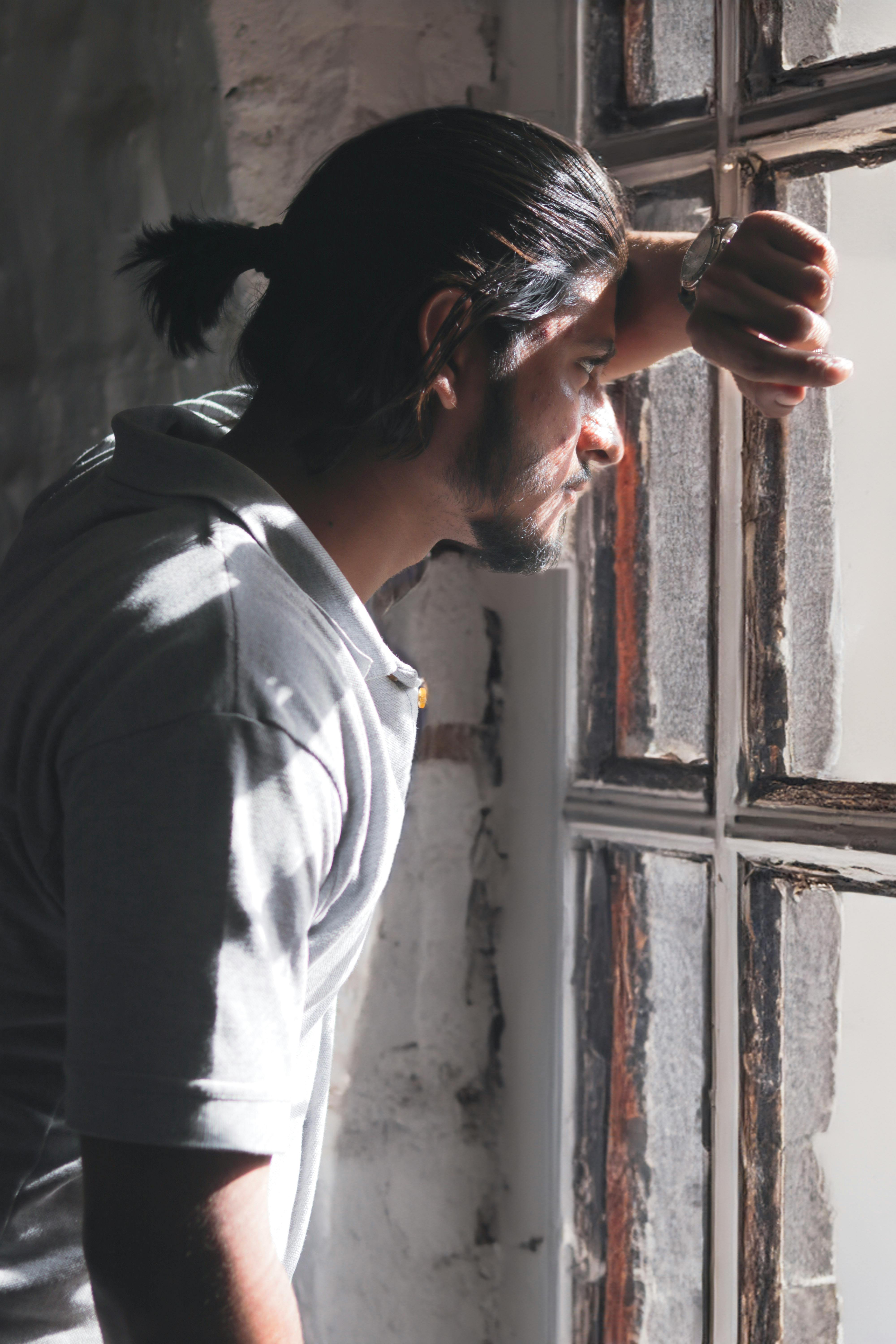 Man Looking through Windows · Free Stock Photo