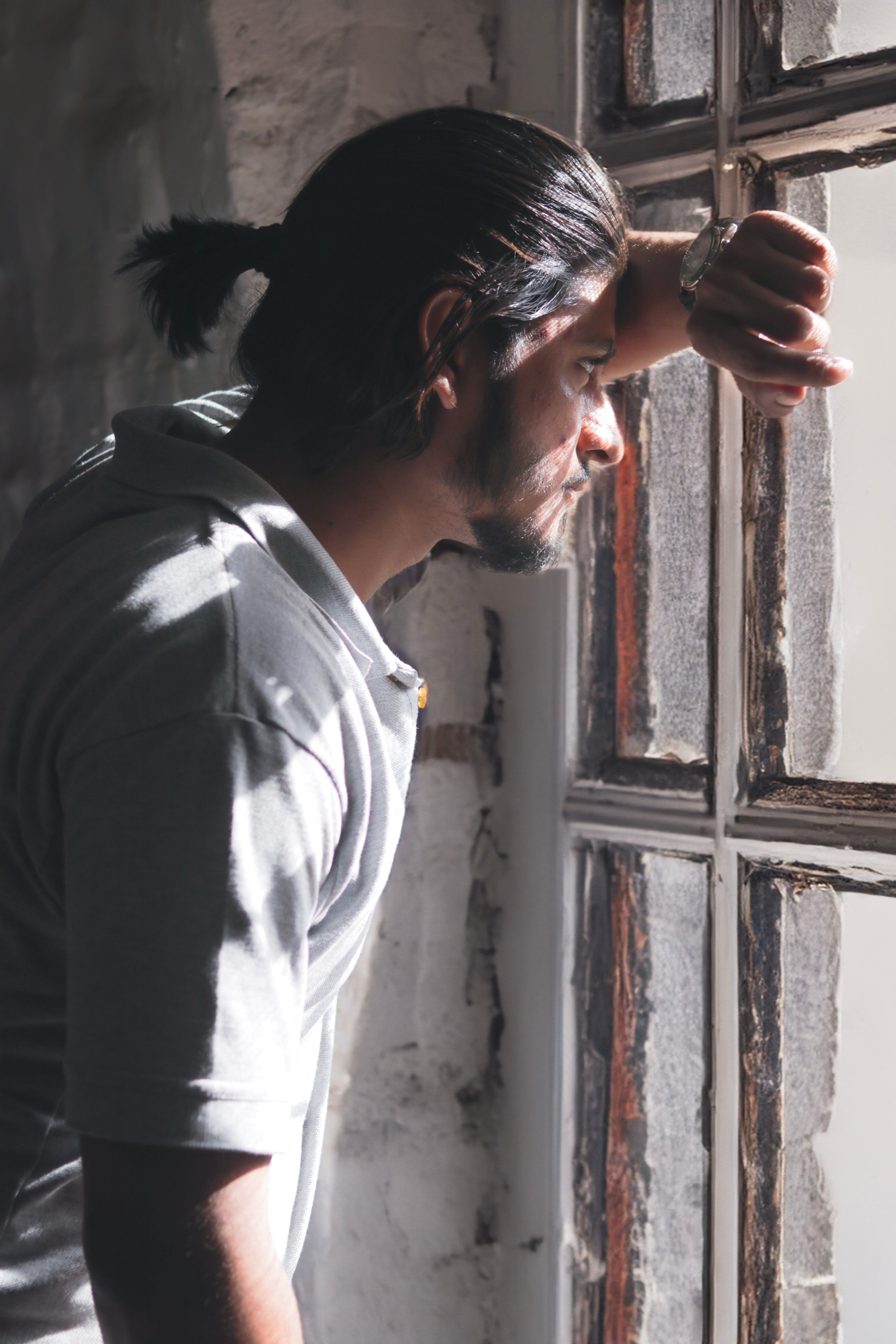 Man Looking through Windows · Free Stock Photo