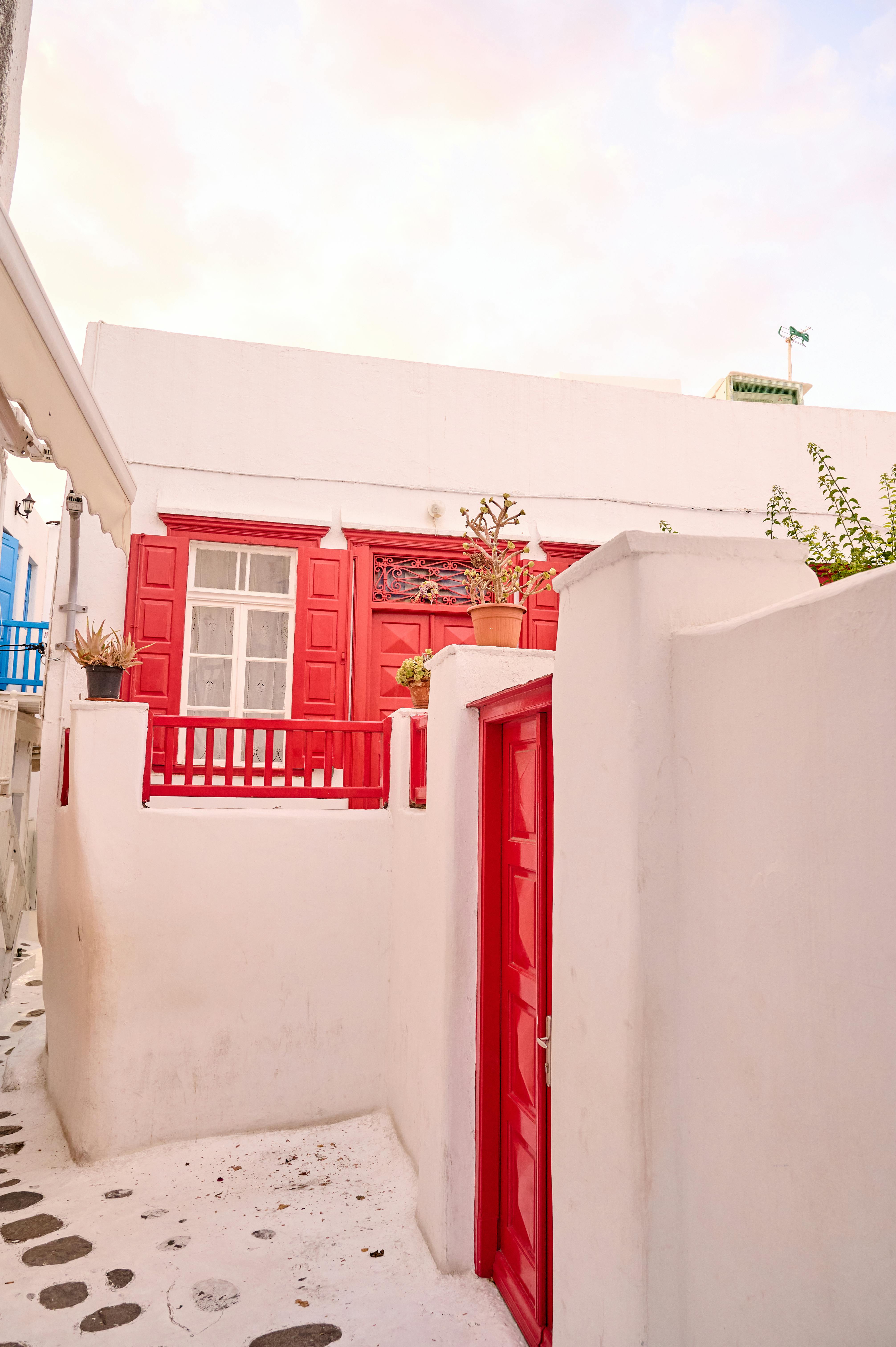 Exterior of a White House with Red Door and Windows · Free Stock Photo