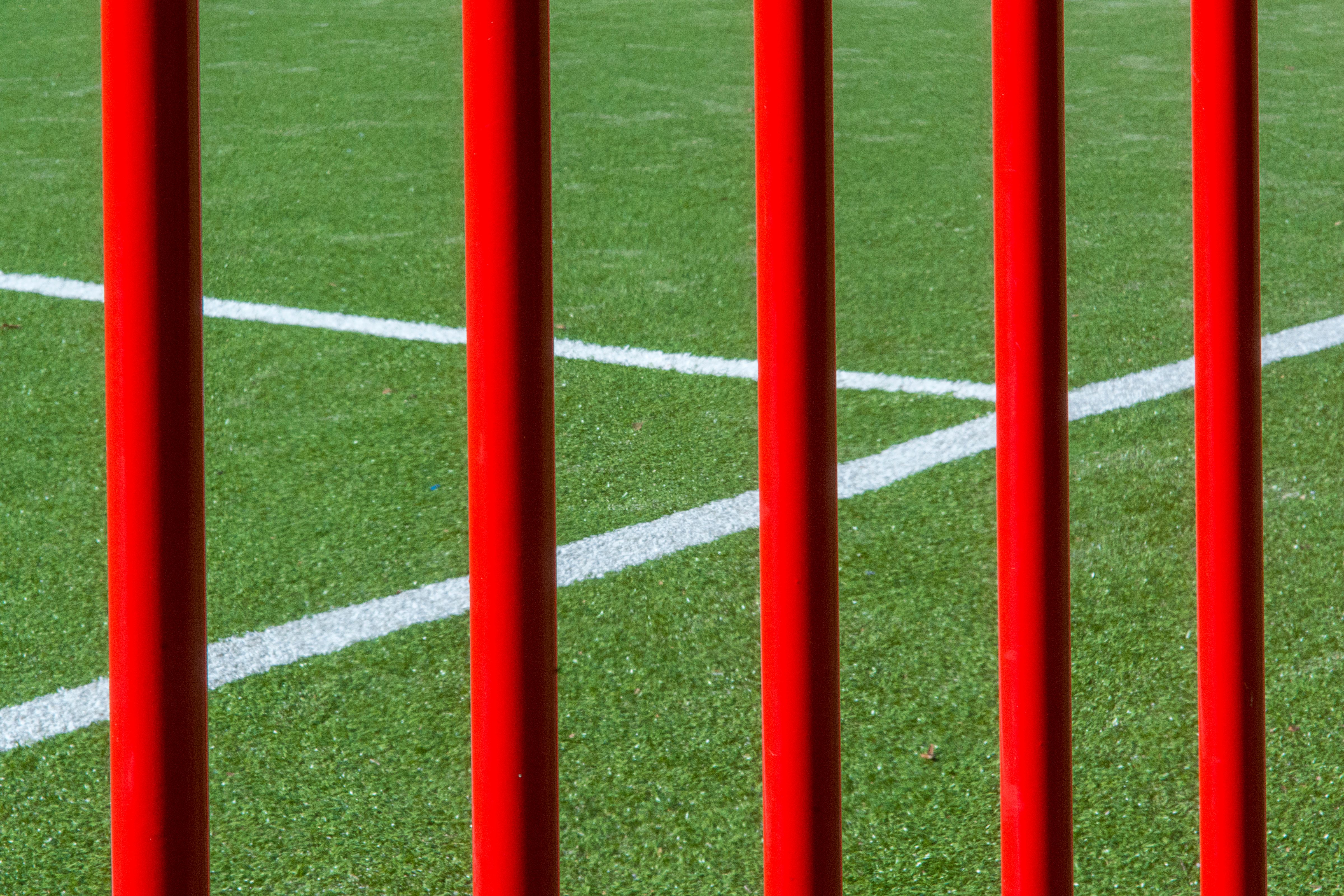 Soccer Field behind Bars · Free Stock Photo
