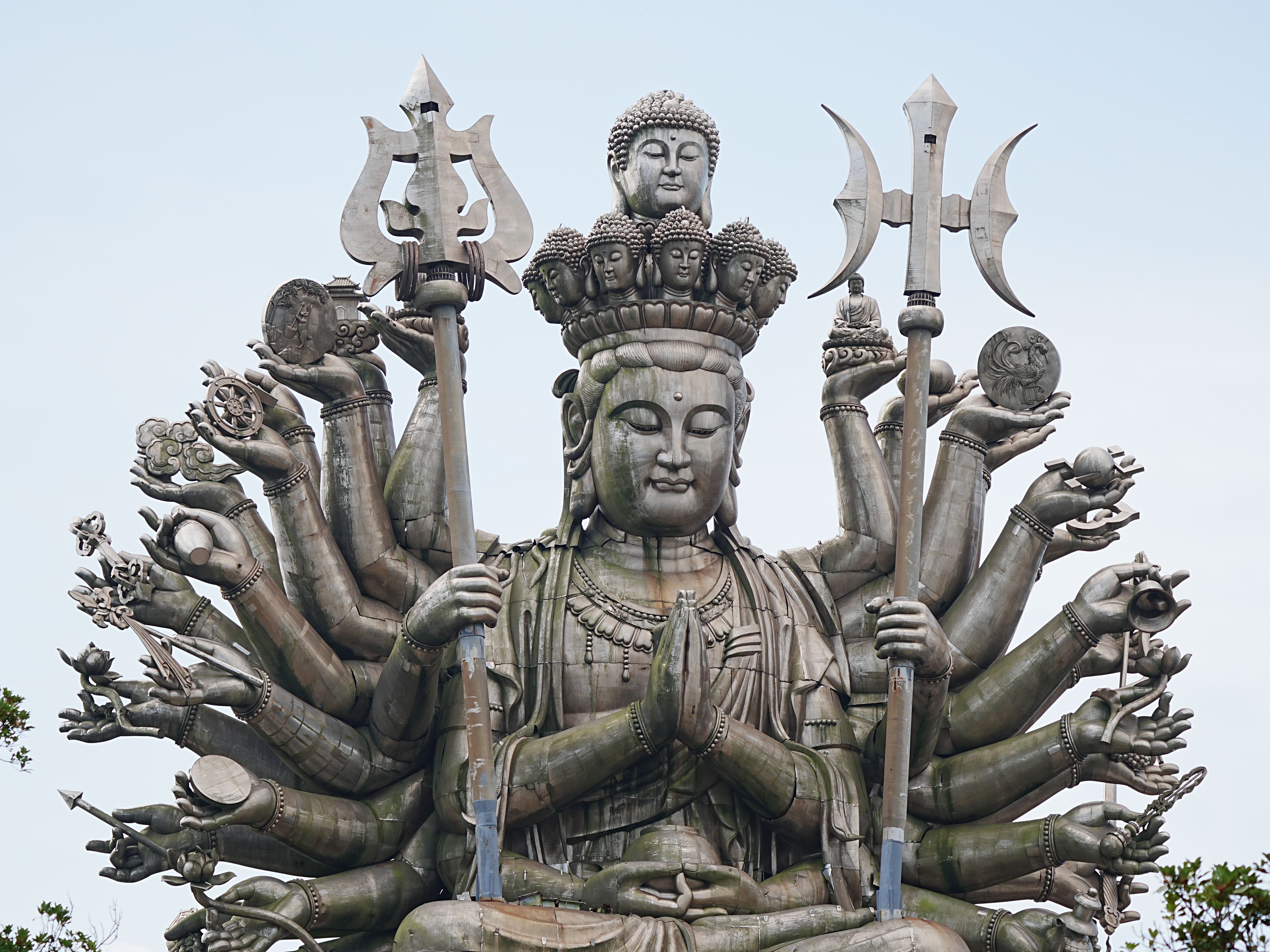 A statue of a buddha with many arms and hands · Free Stock Photo