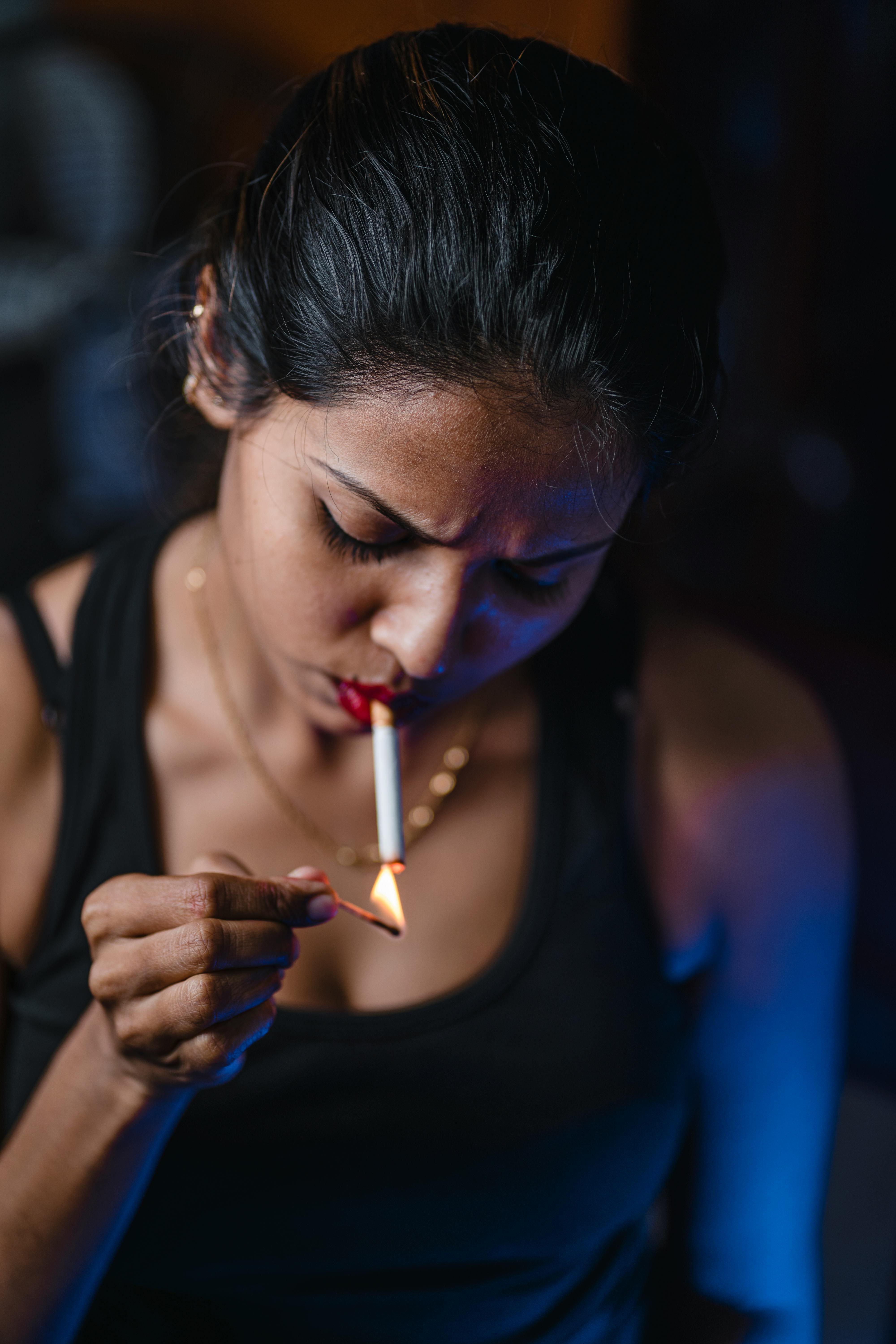 A Woman Lighting a Cigarette · Free Stock Photo