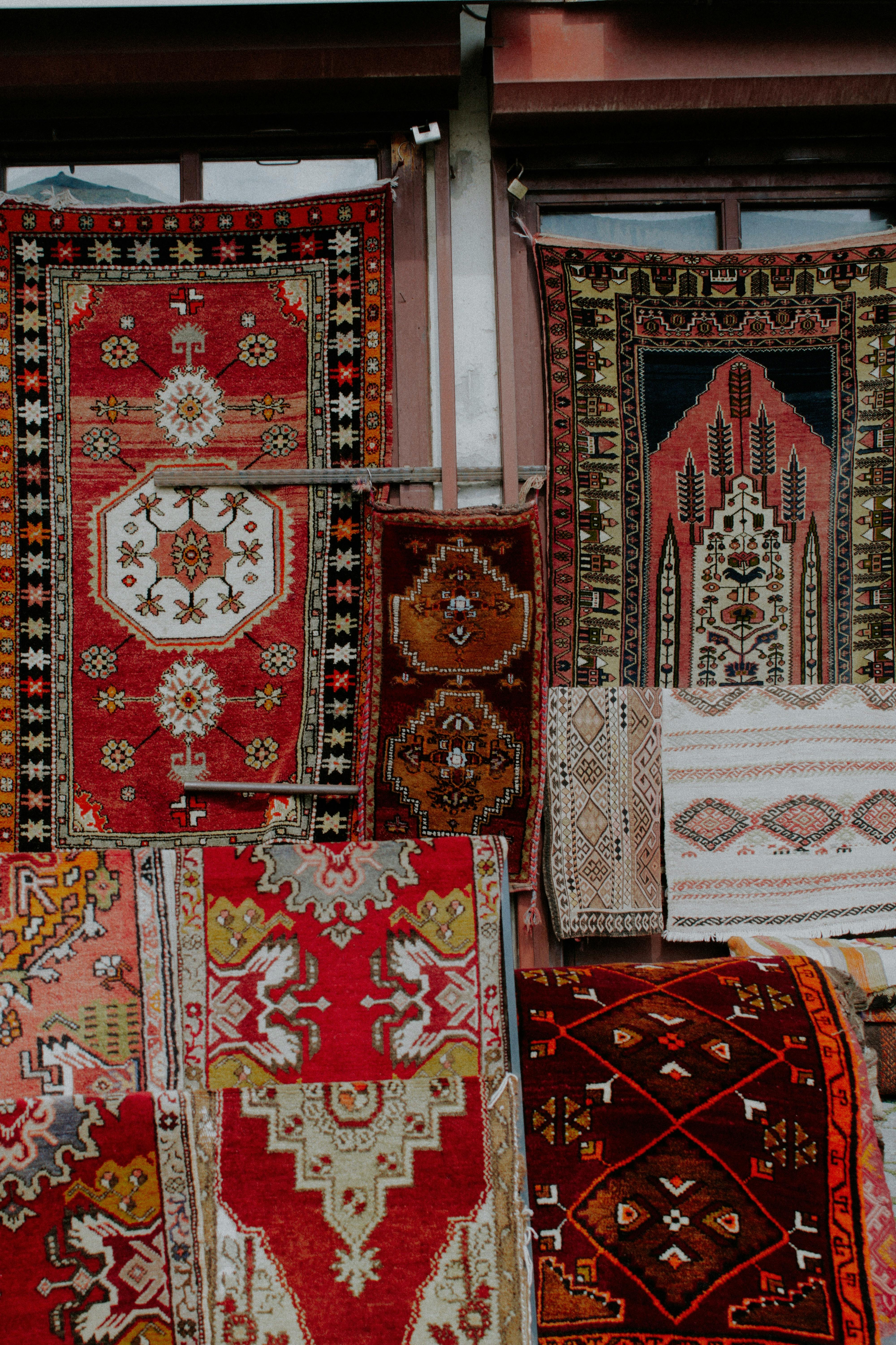 Patterned Rugs Hanging on a Building · Free Stock Photo