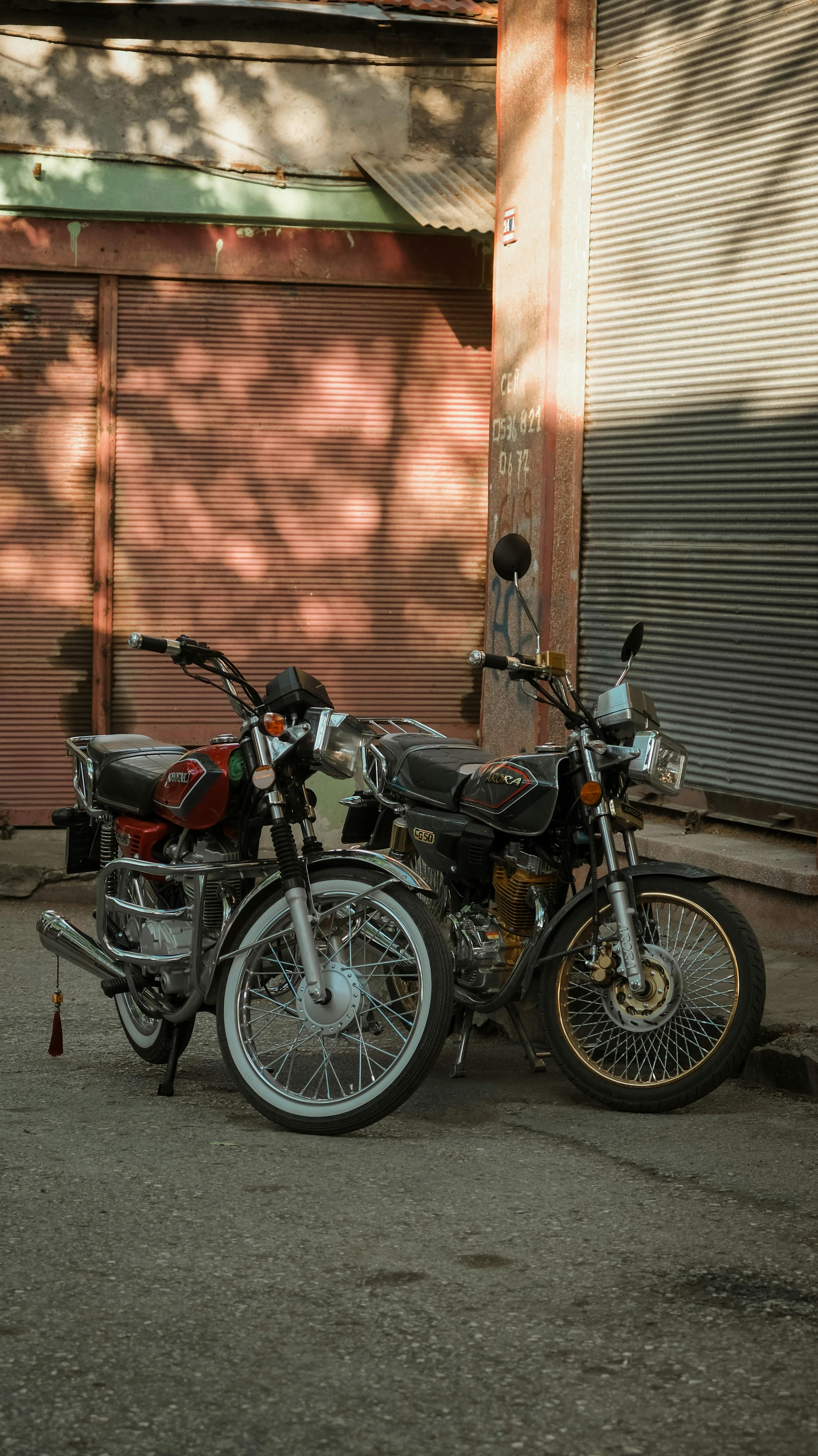 Two Motorcycles Parked on a Street by the Building · Free Stock Photo