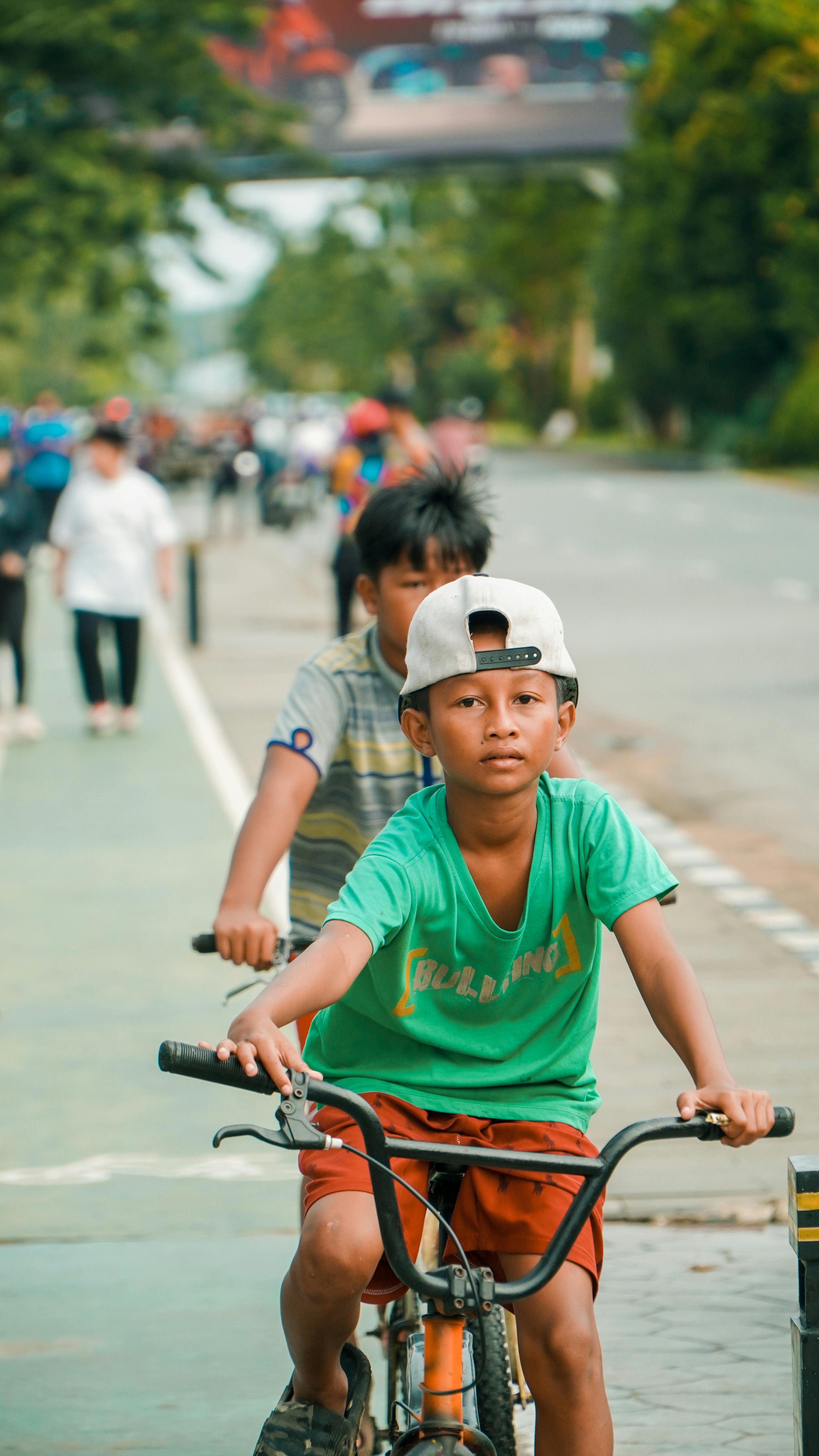 Children Cycling on a Street in a City · Free Stock Photo
