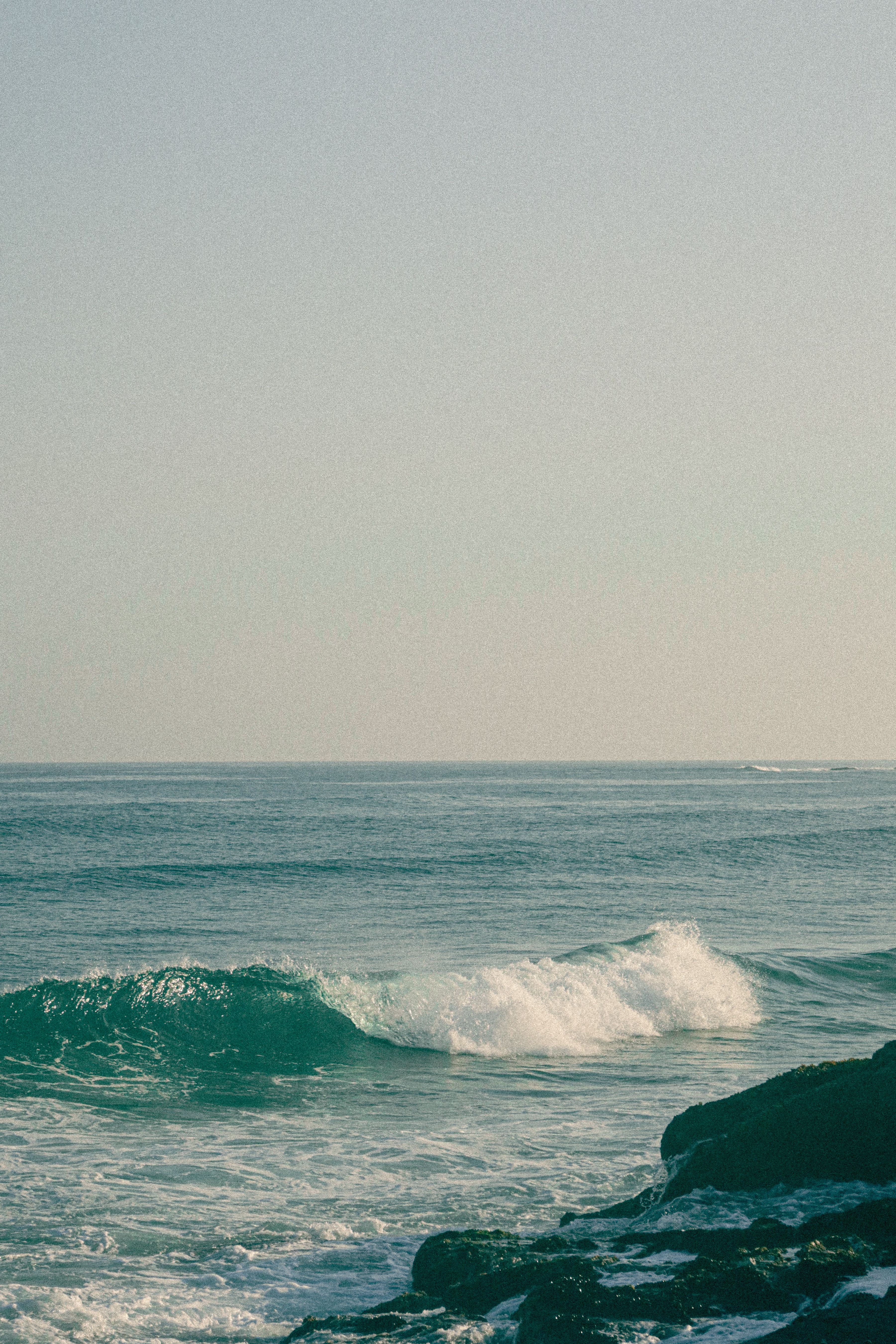 Small Wave Splashing at a Seashore · Free Stock Photo