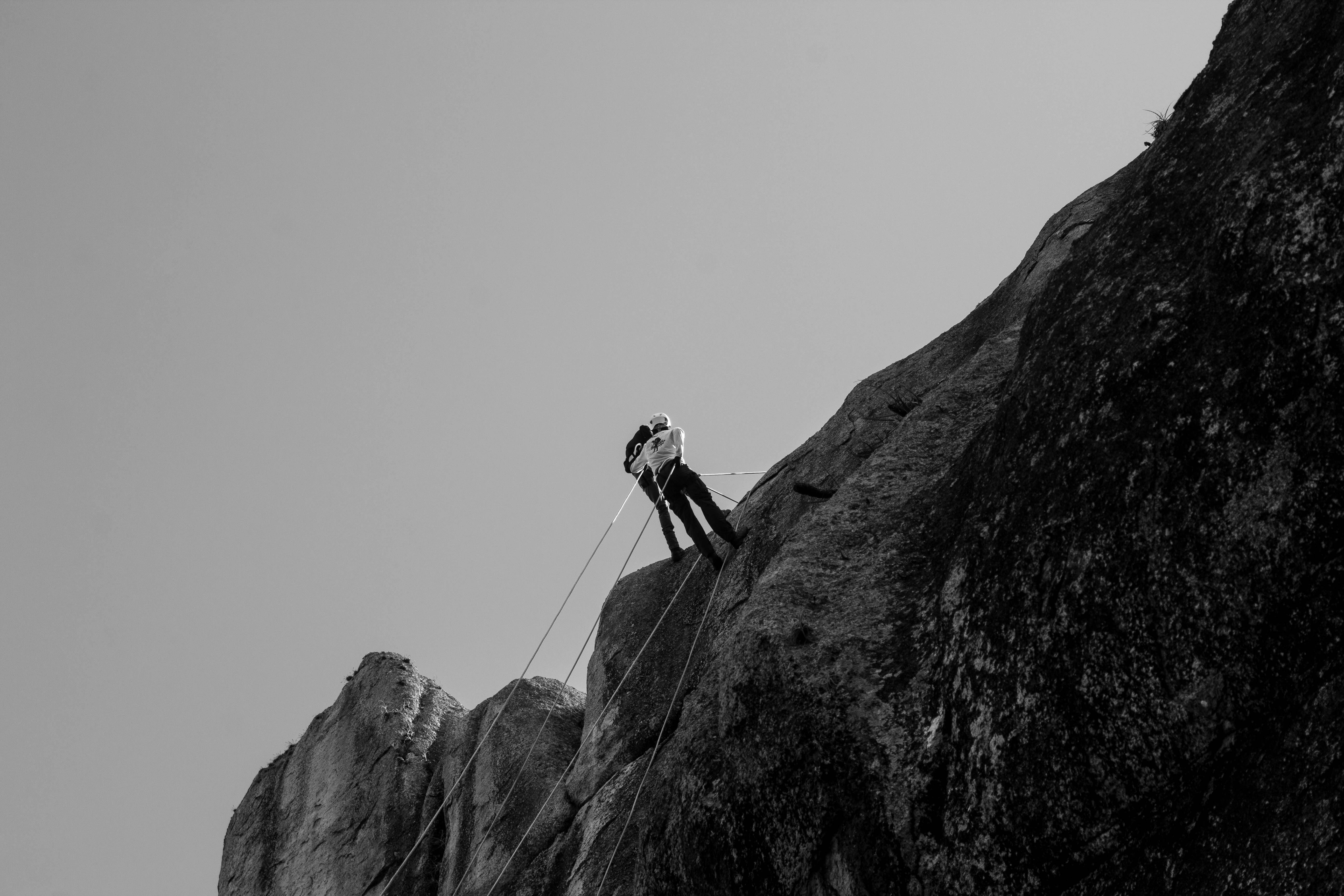Photo of Person Standing on Cliff Edge · Free Stock Photo