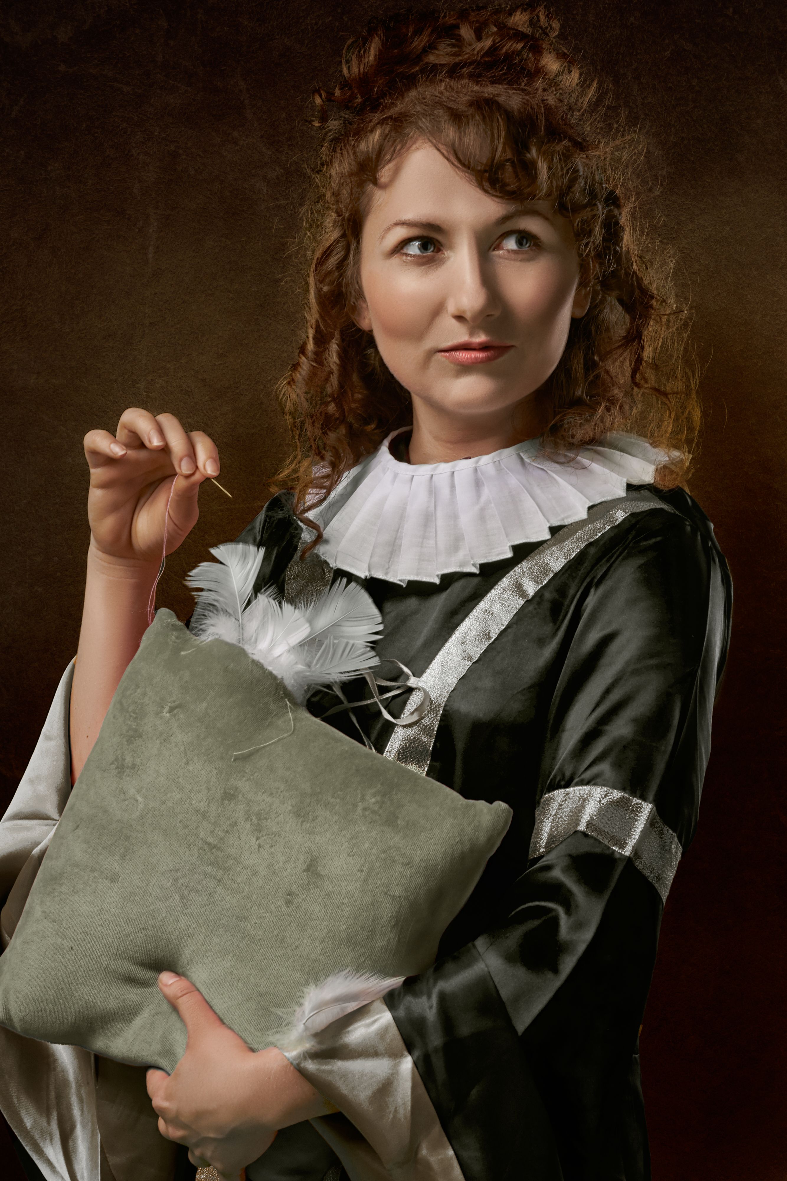Photo of Woman Ripped Holding Throw Pillow in One Hand and Needle with ...