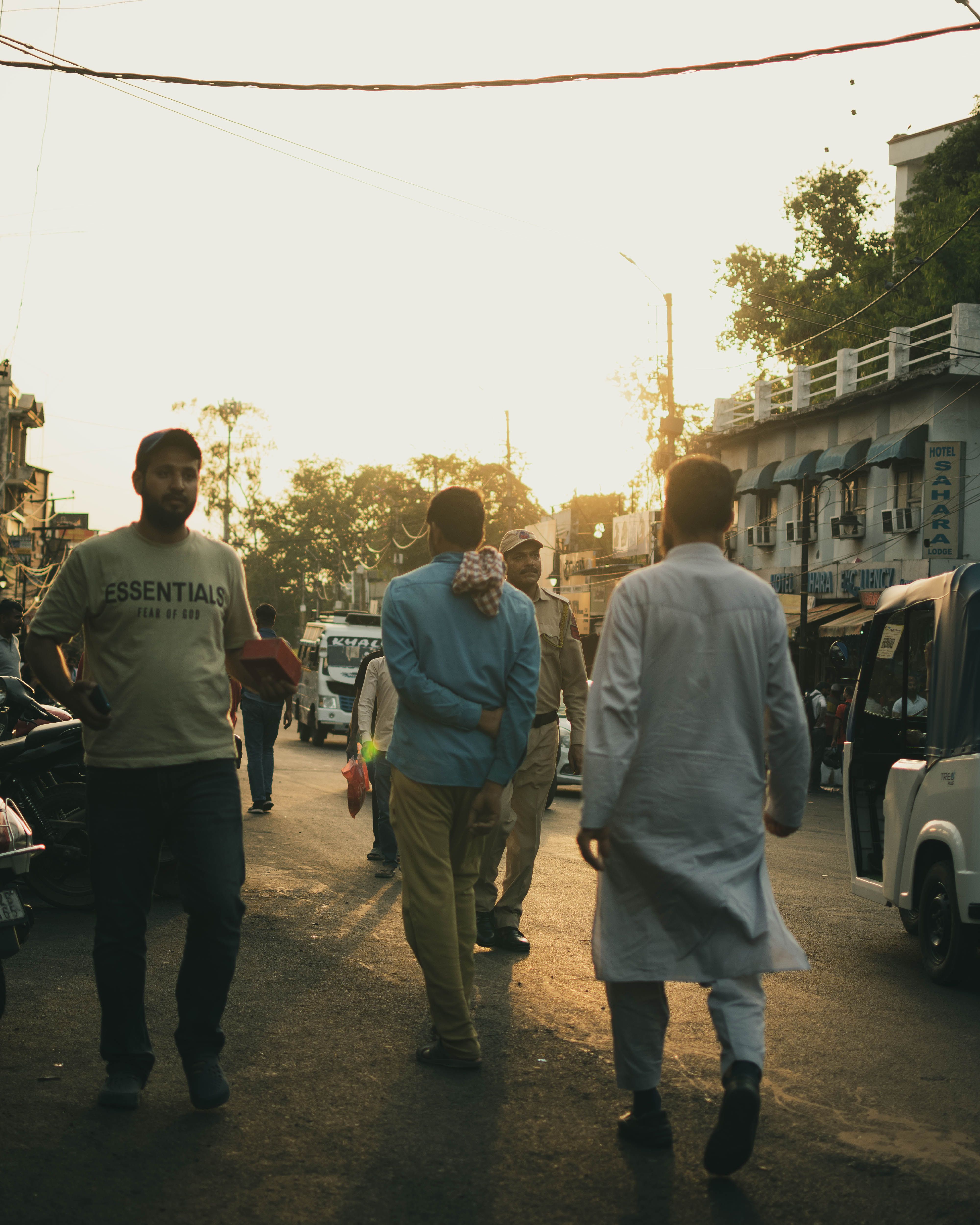 Men Walking on Street at Sunset · Free Stock Photo
