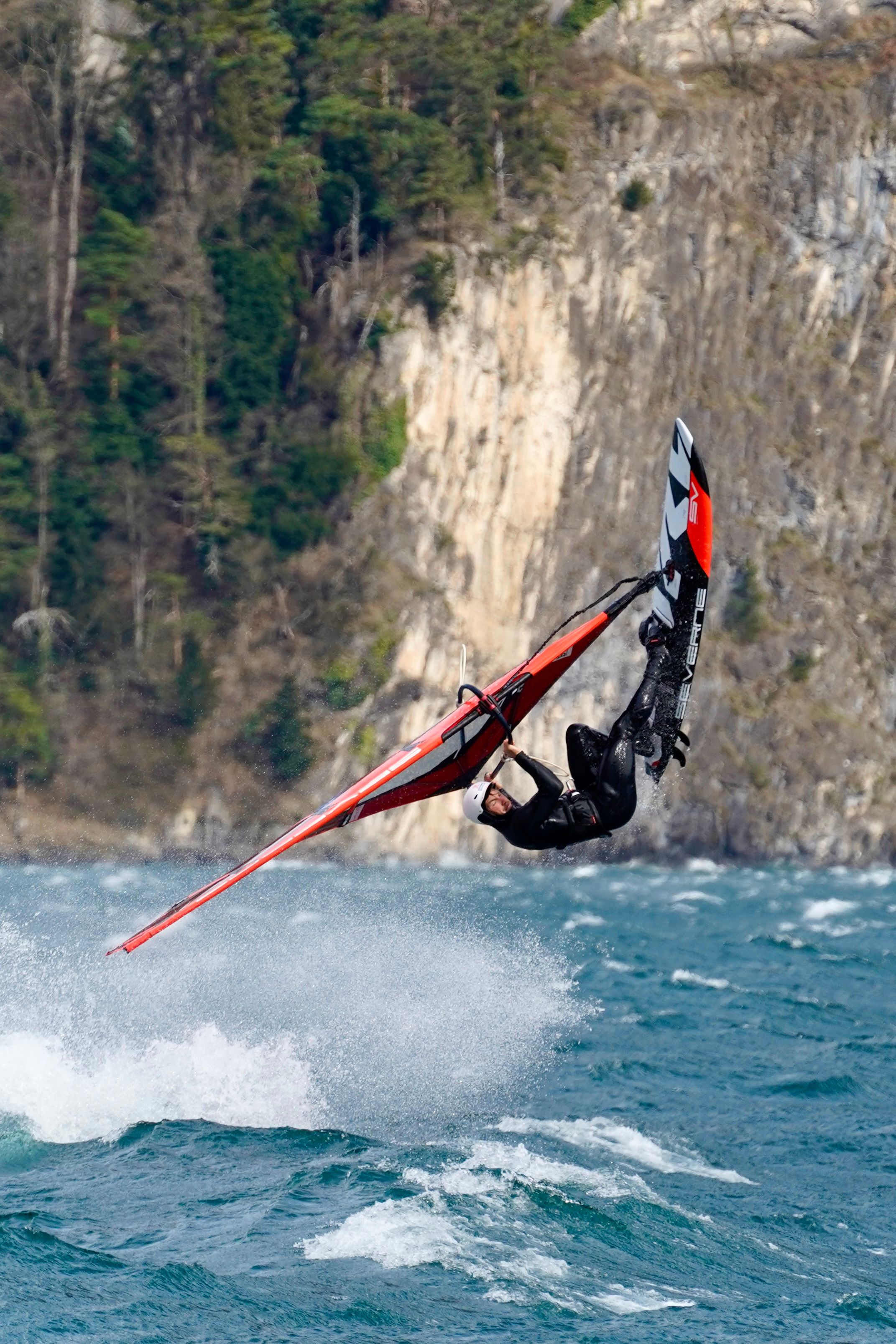 Man Windsurfing and Jumping on Seashore · Free Stock Photo