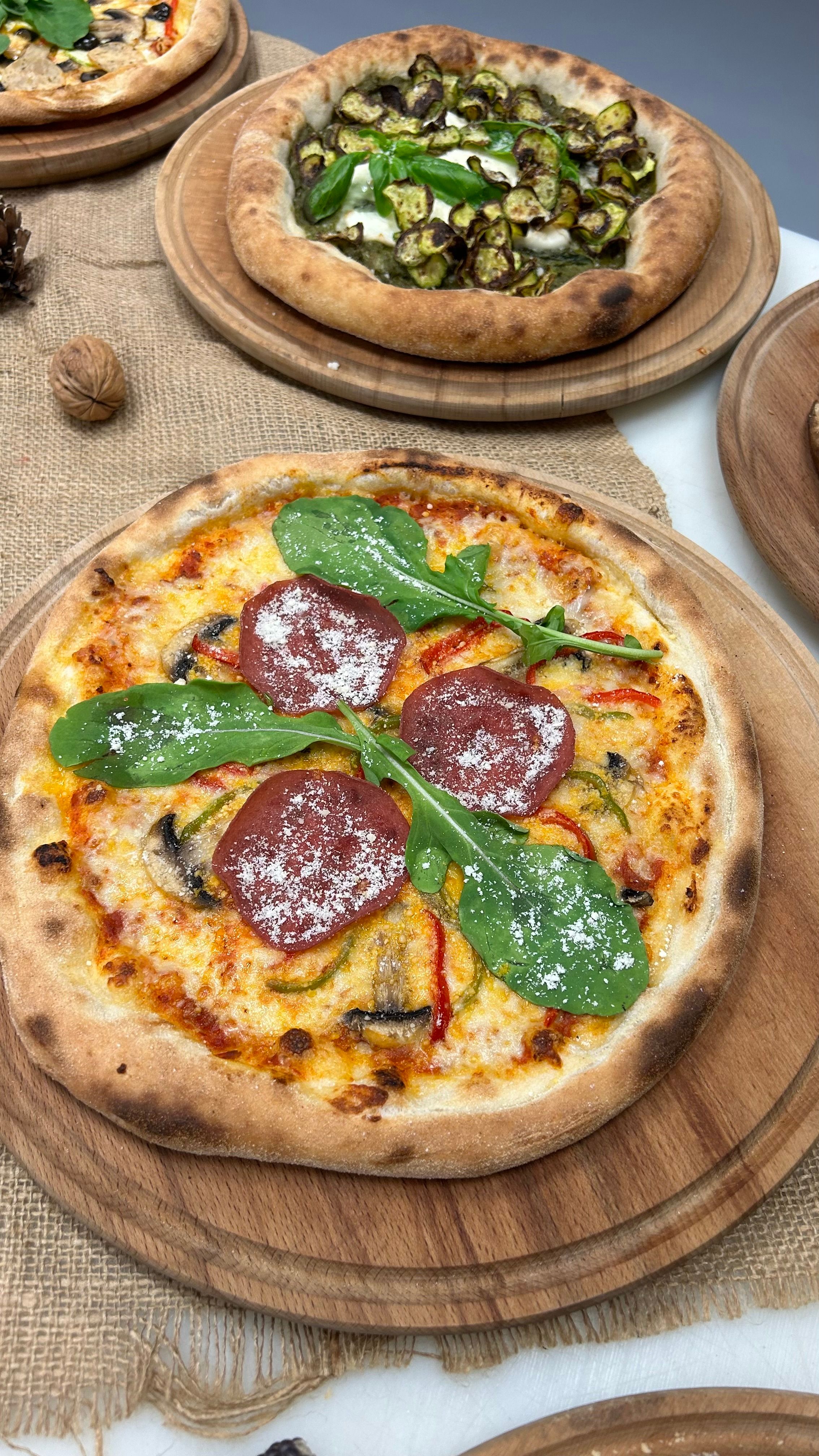 Pizza with Salami Mushrooms Peppers and Arugula in a Restaurant · Free ...