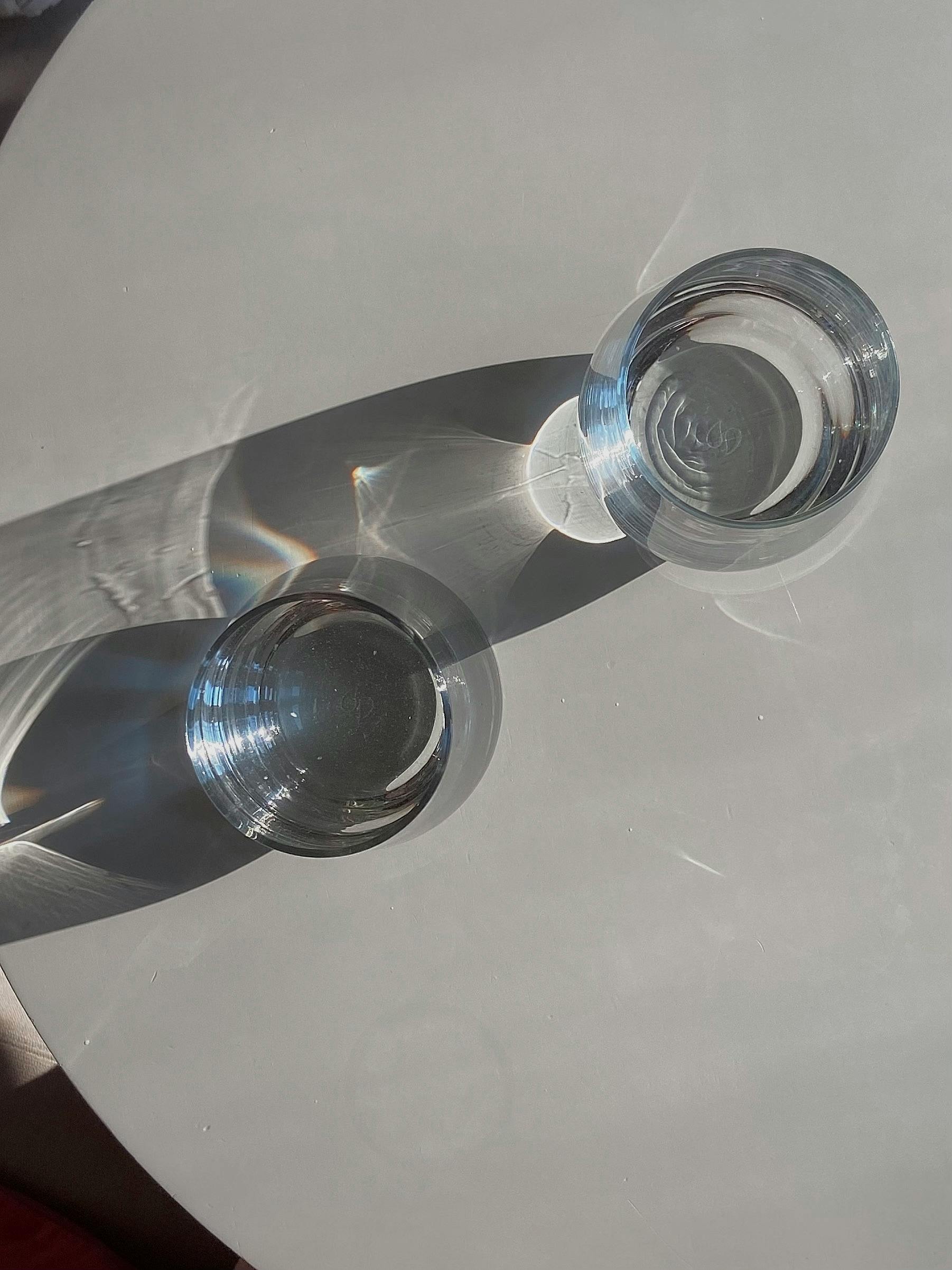 Two Glasses Reflecting Light On the Table · Free Stock Photo