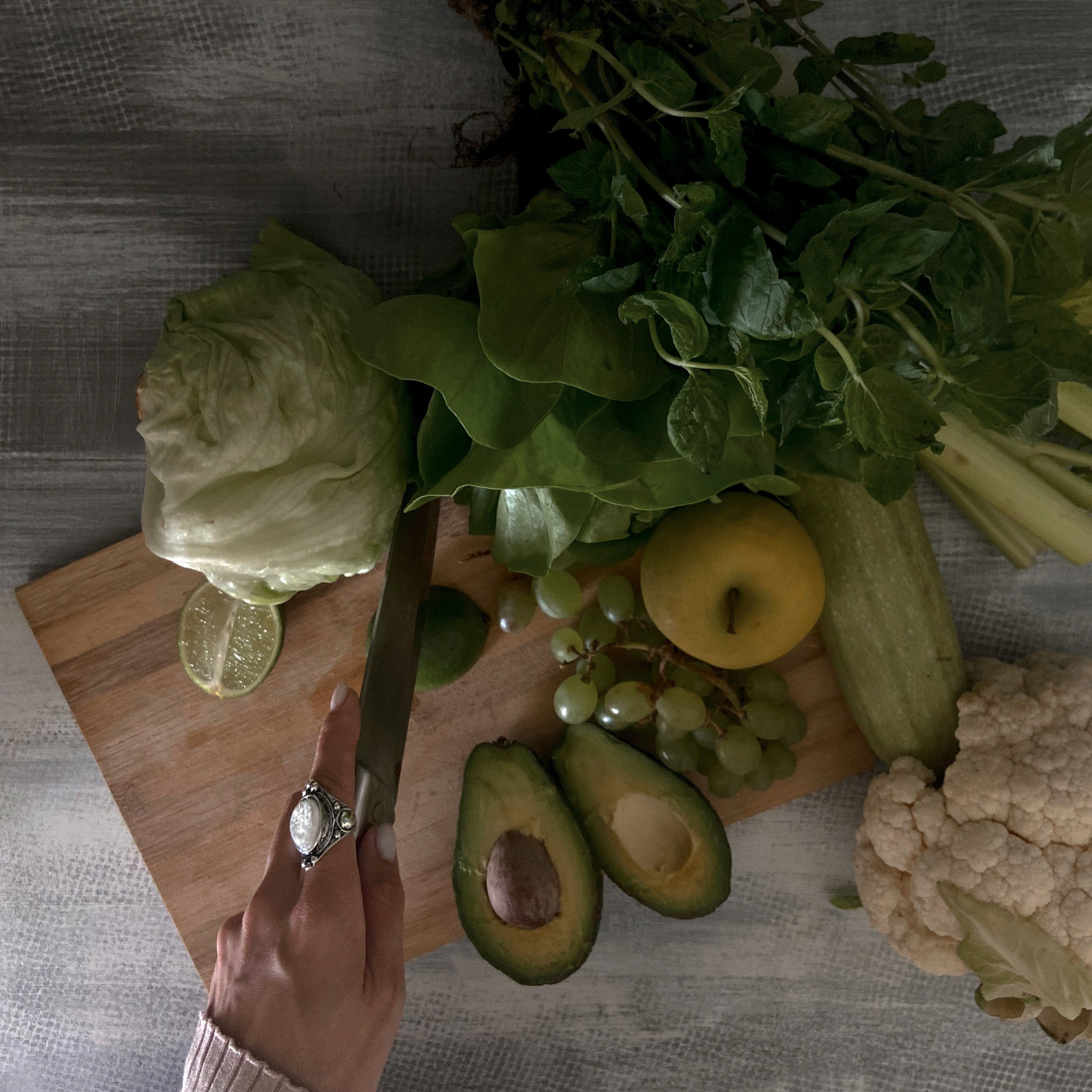 Hand Cutting Vegetables on Wooden Cutting Board · Free Stock Photo