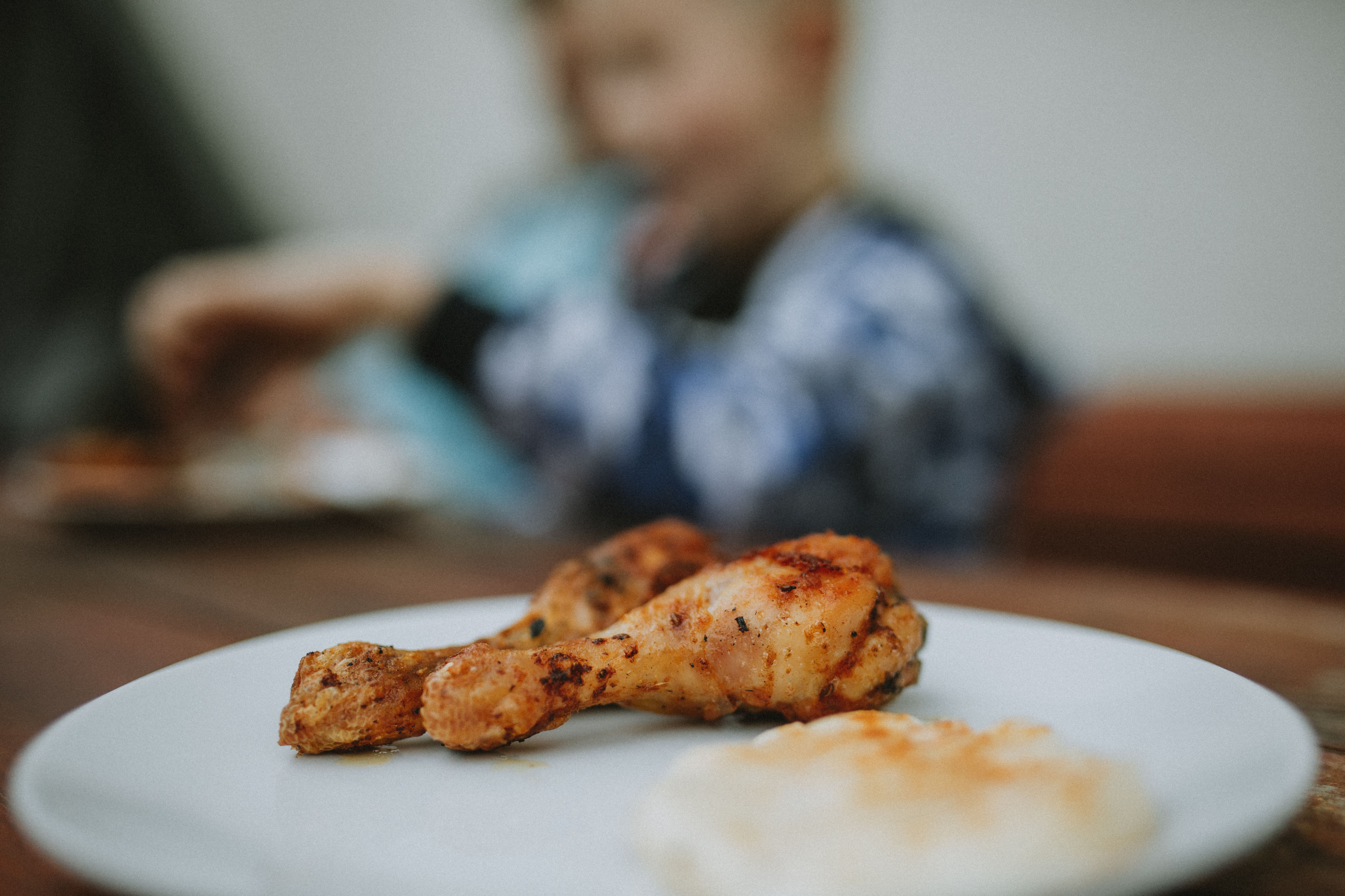 Close-up of Grilled Chicken Legs on a Plate · Free Stock Photo