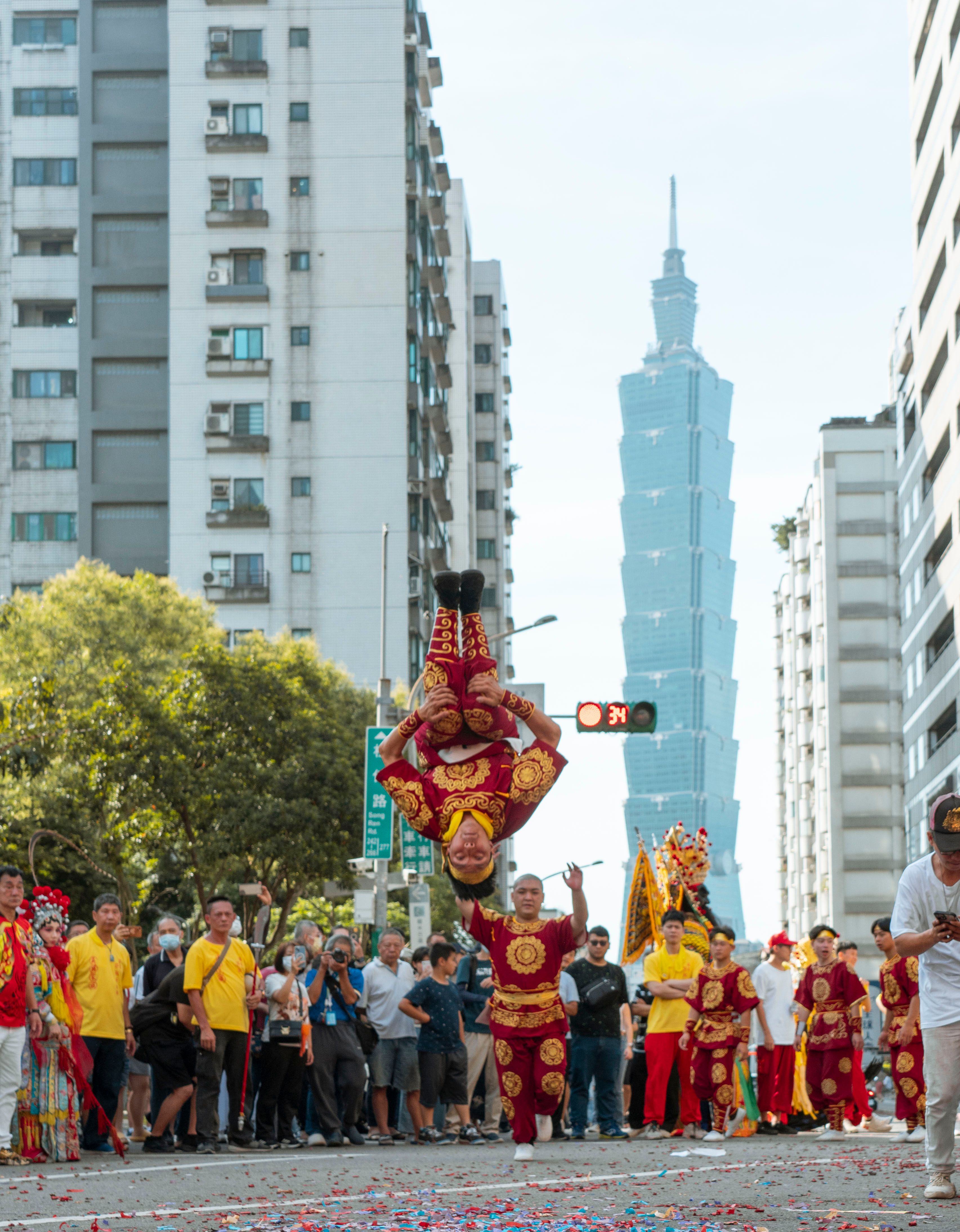 Dancer in Red Costume Doing Flip on Street · Free Stock Photo