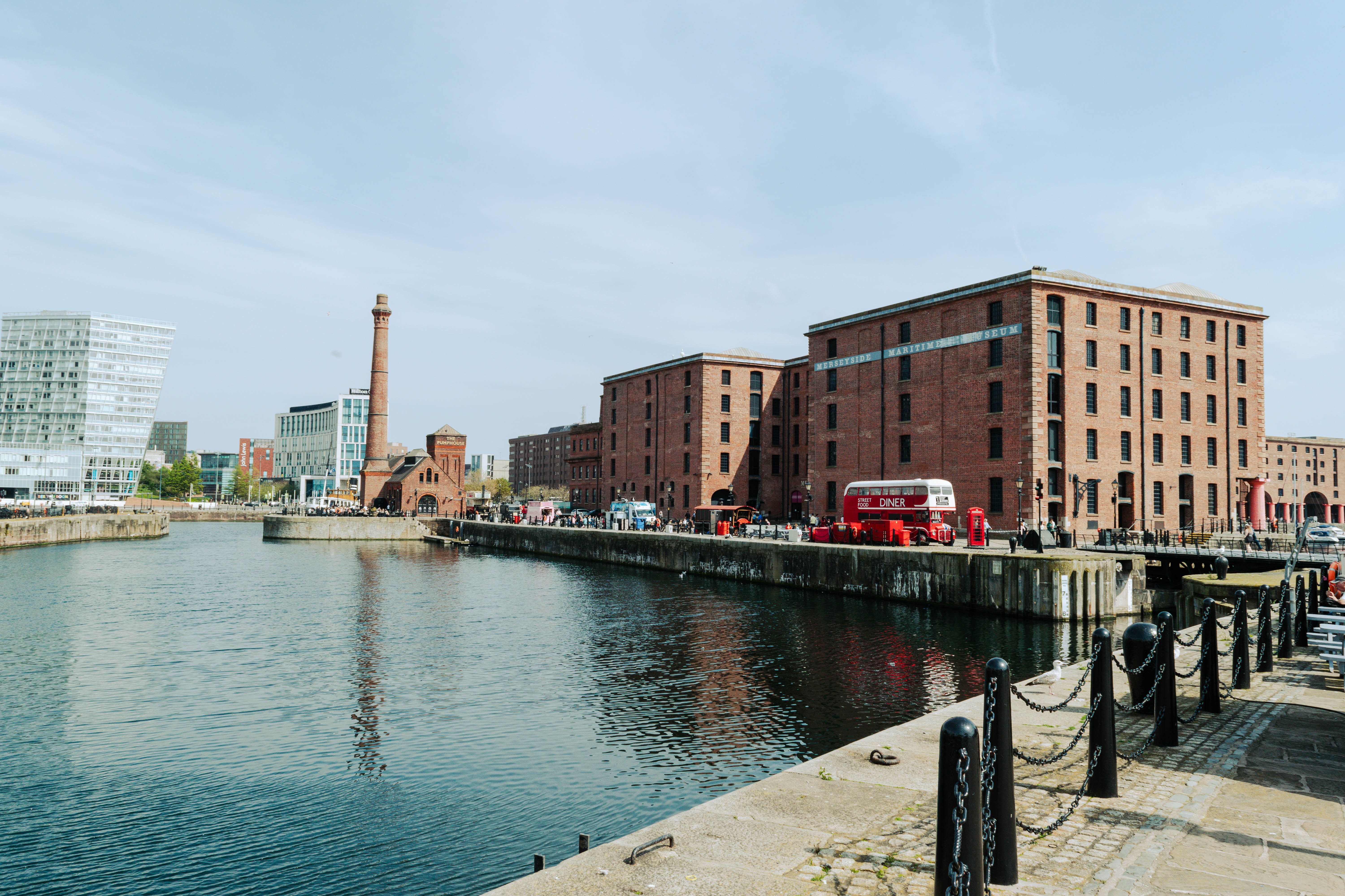 The water is near a dock with buildings · Free Stock Photo