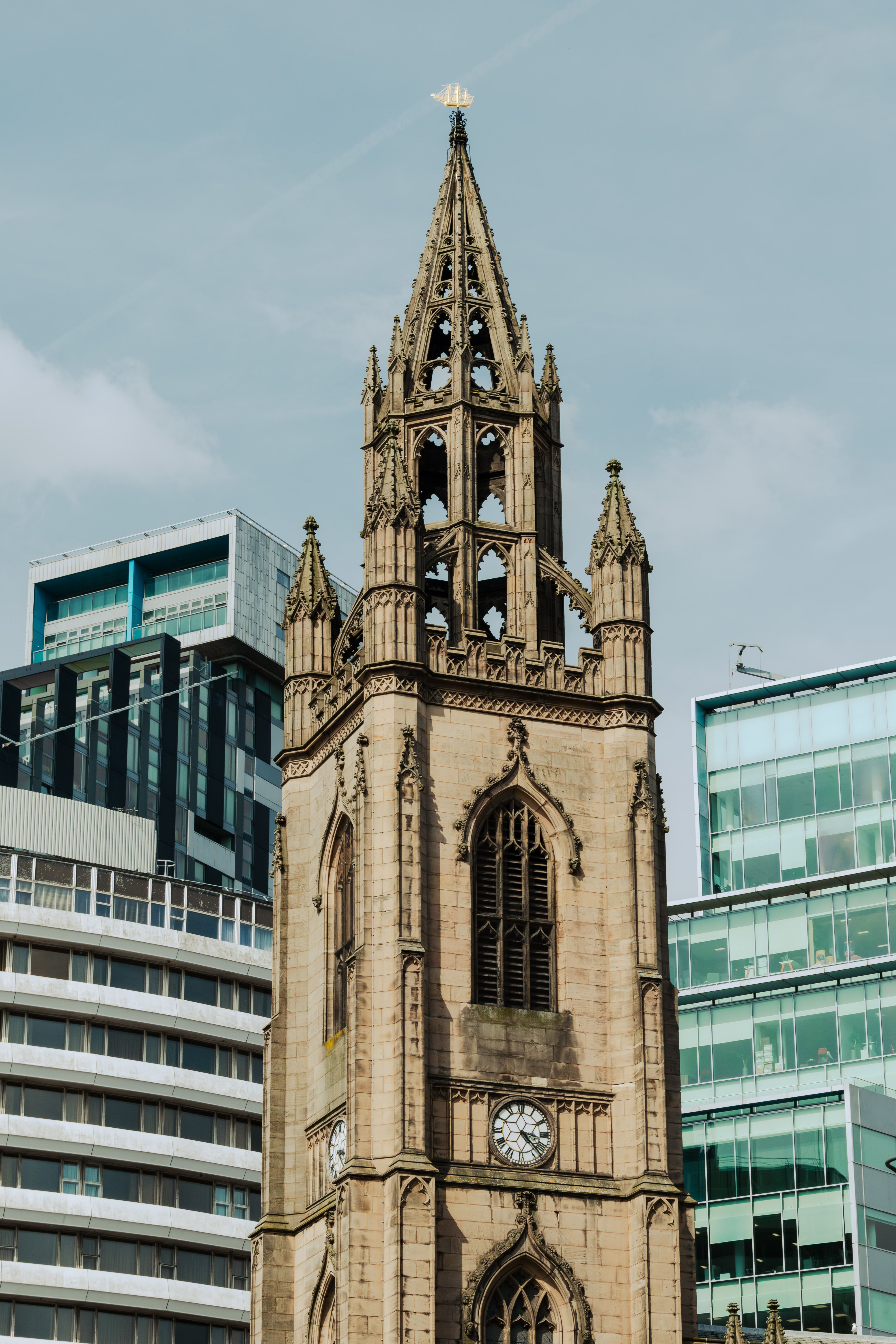 A tall church tower with a clock on top · Free Stock Photo