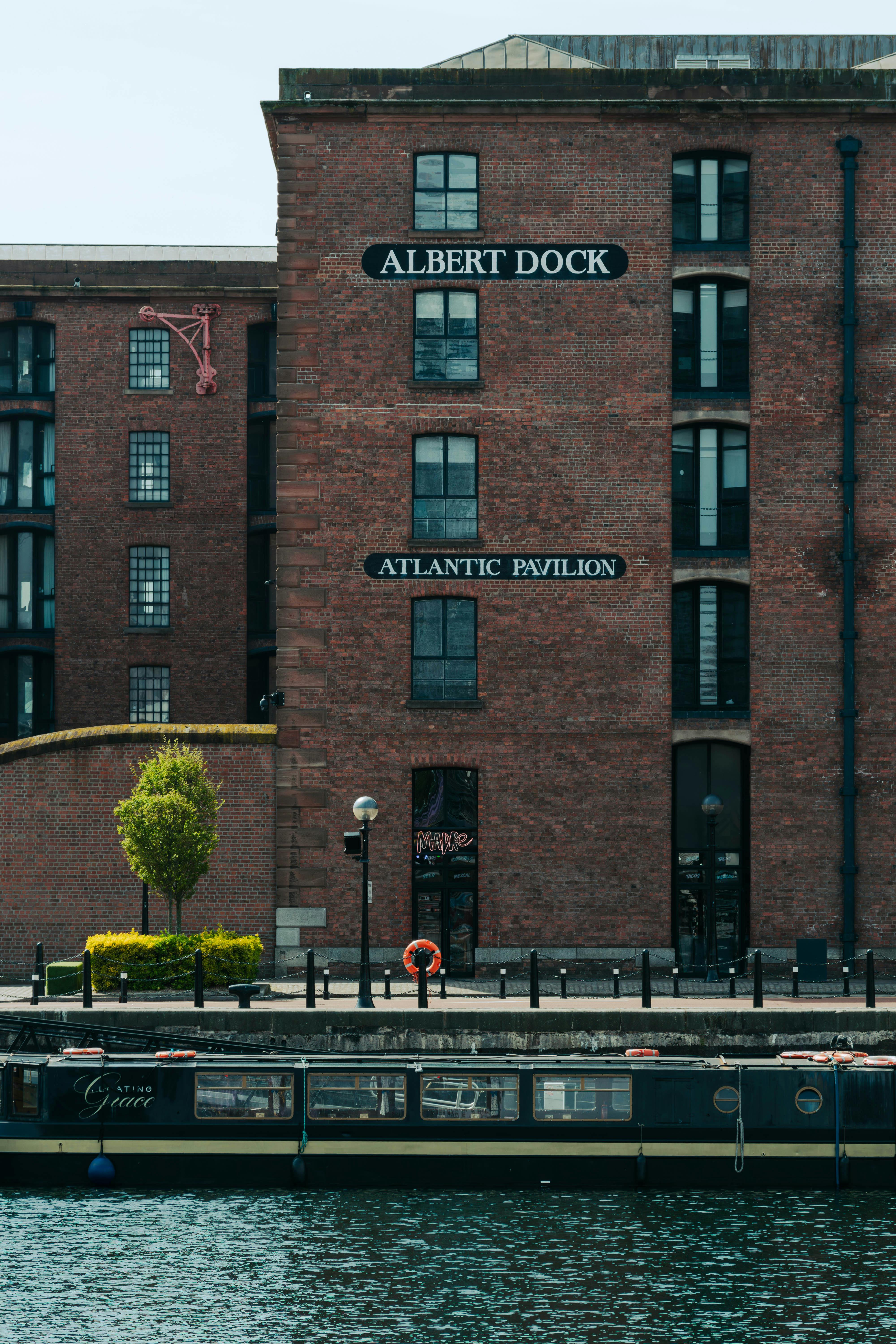 Barge on Canal by Royal Albert Dock Building in Liverpool, England ...