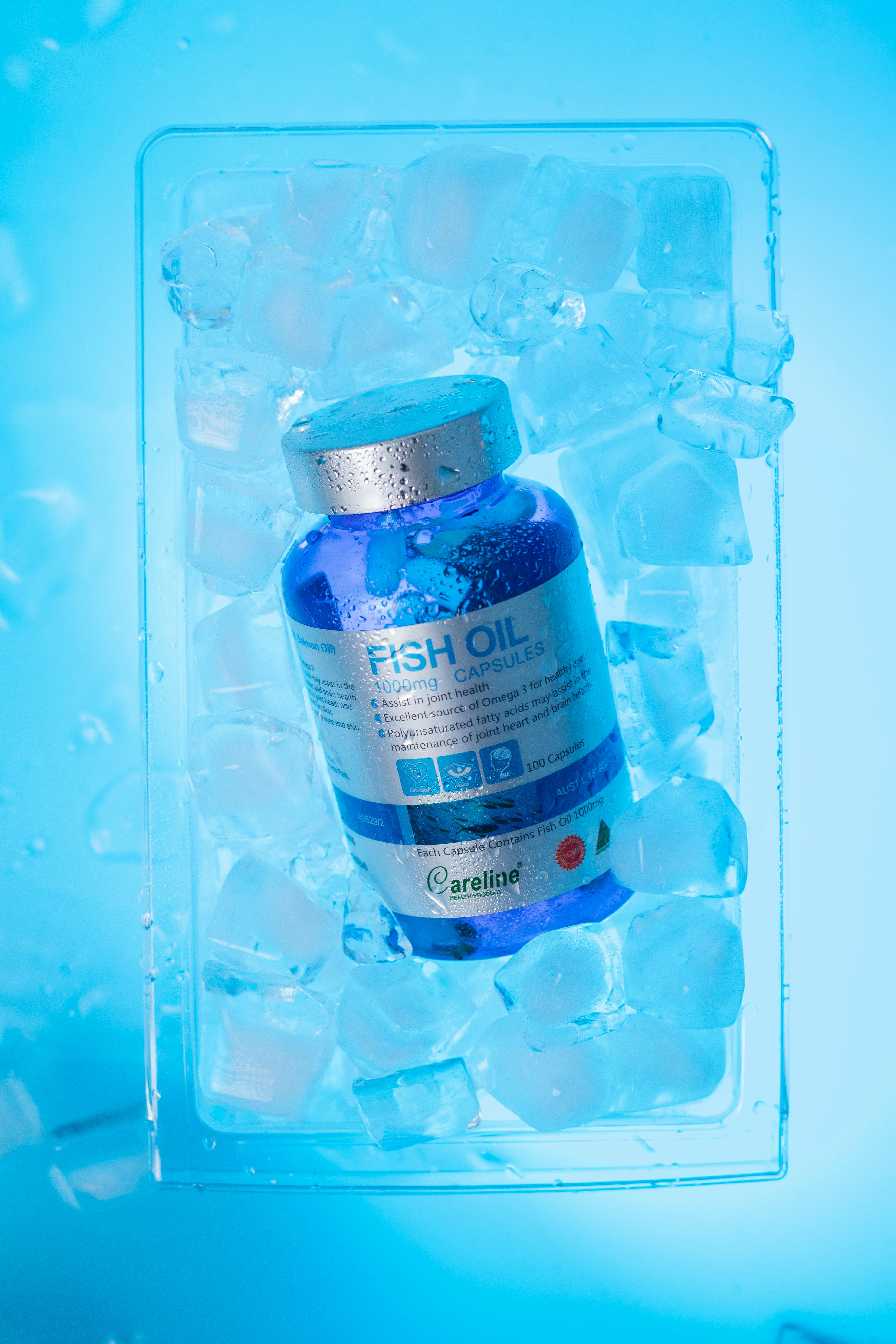 A bottle of blue ice with a blue pill inside · Free Stock Photo