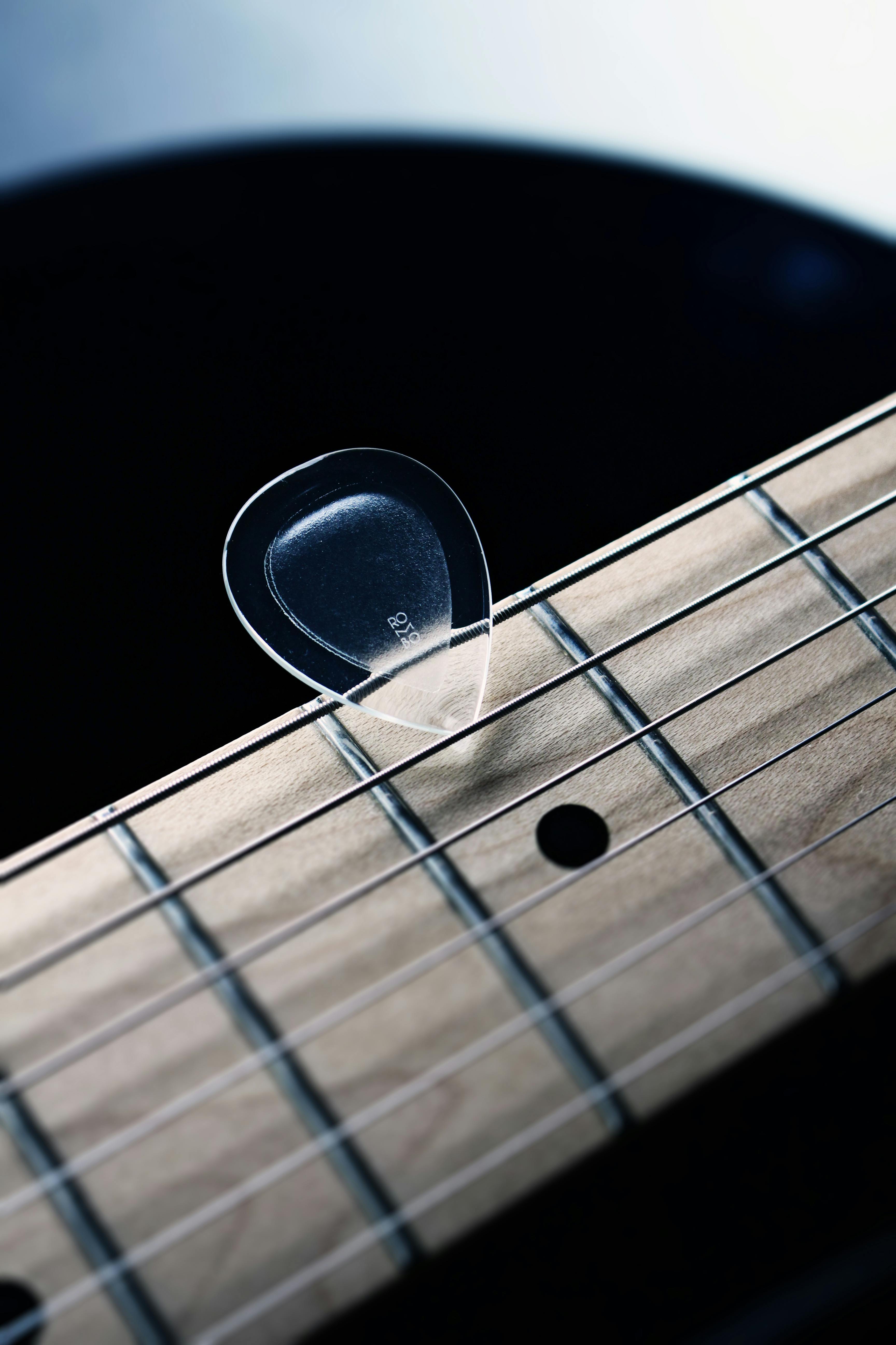 Guitar Pick on Strings · Free Stock Photo