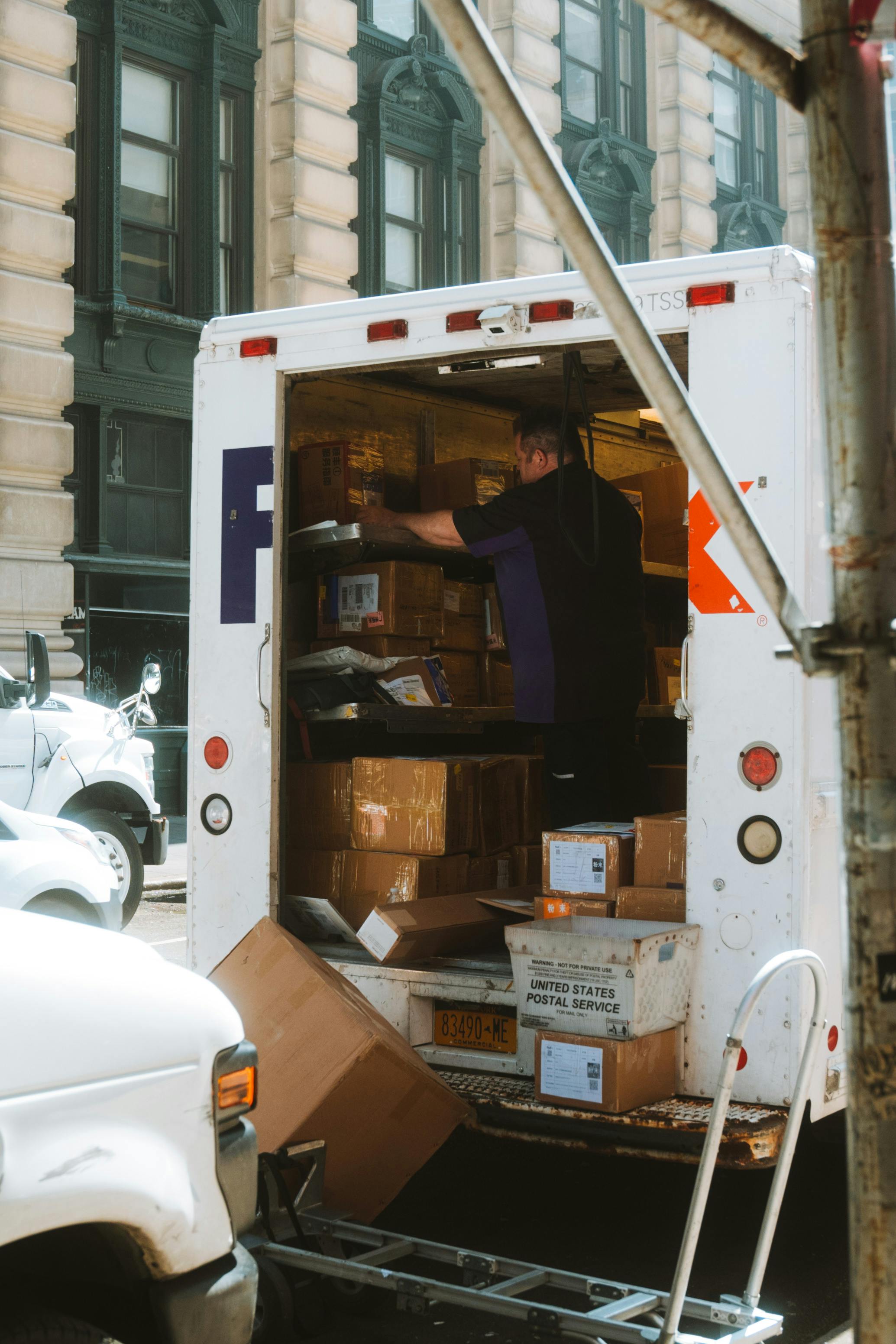 Delivery Driver Loading Truck on Street · Free Stock Photo