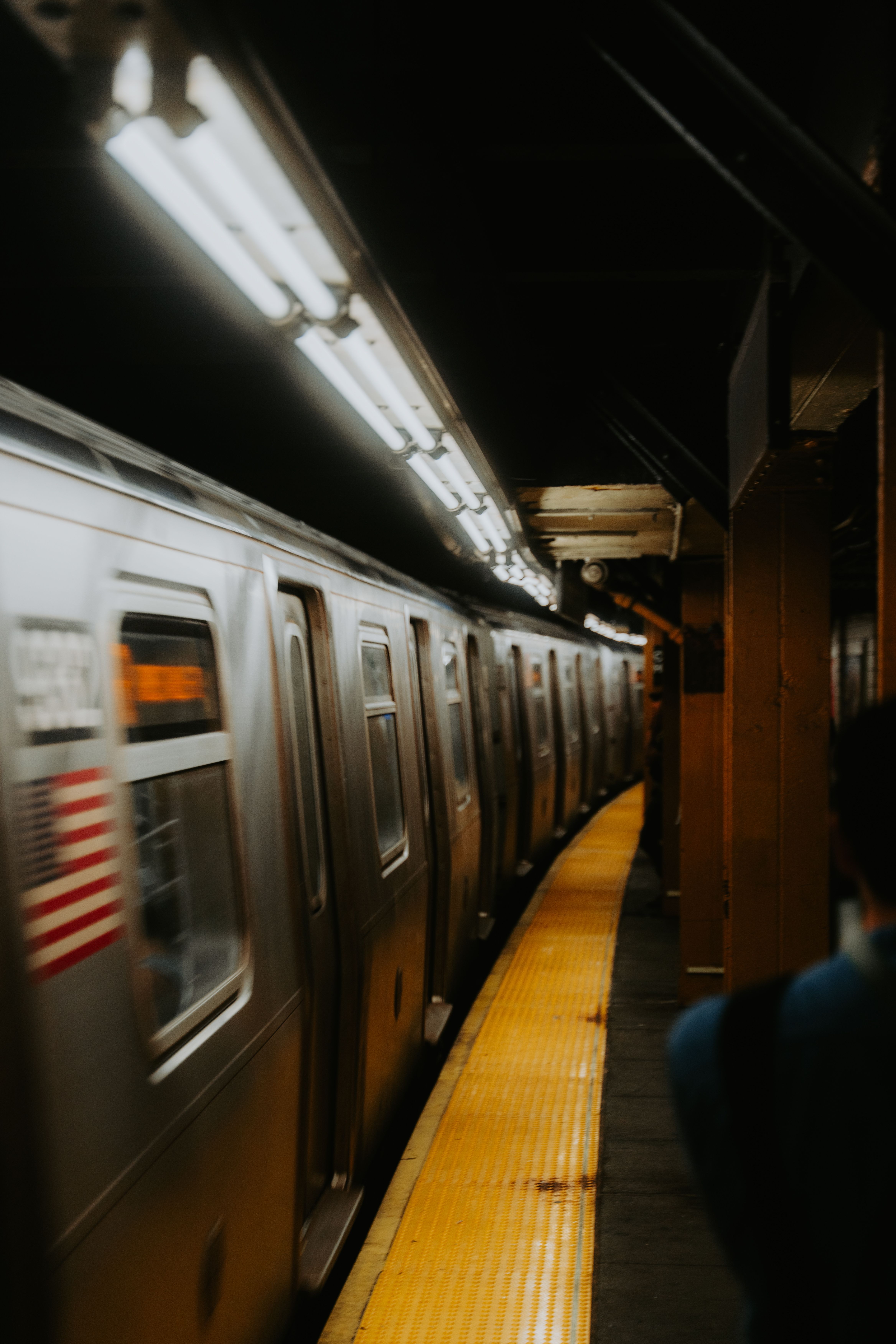 A subway train is moving through a subway station · Free Stock Photo