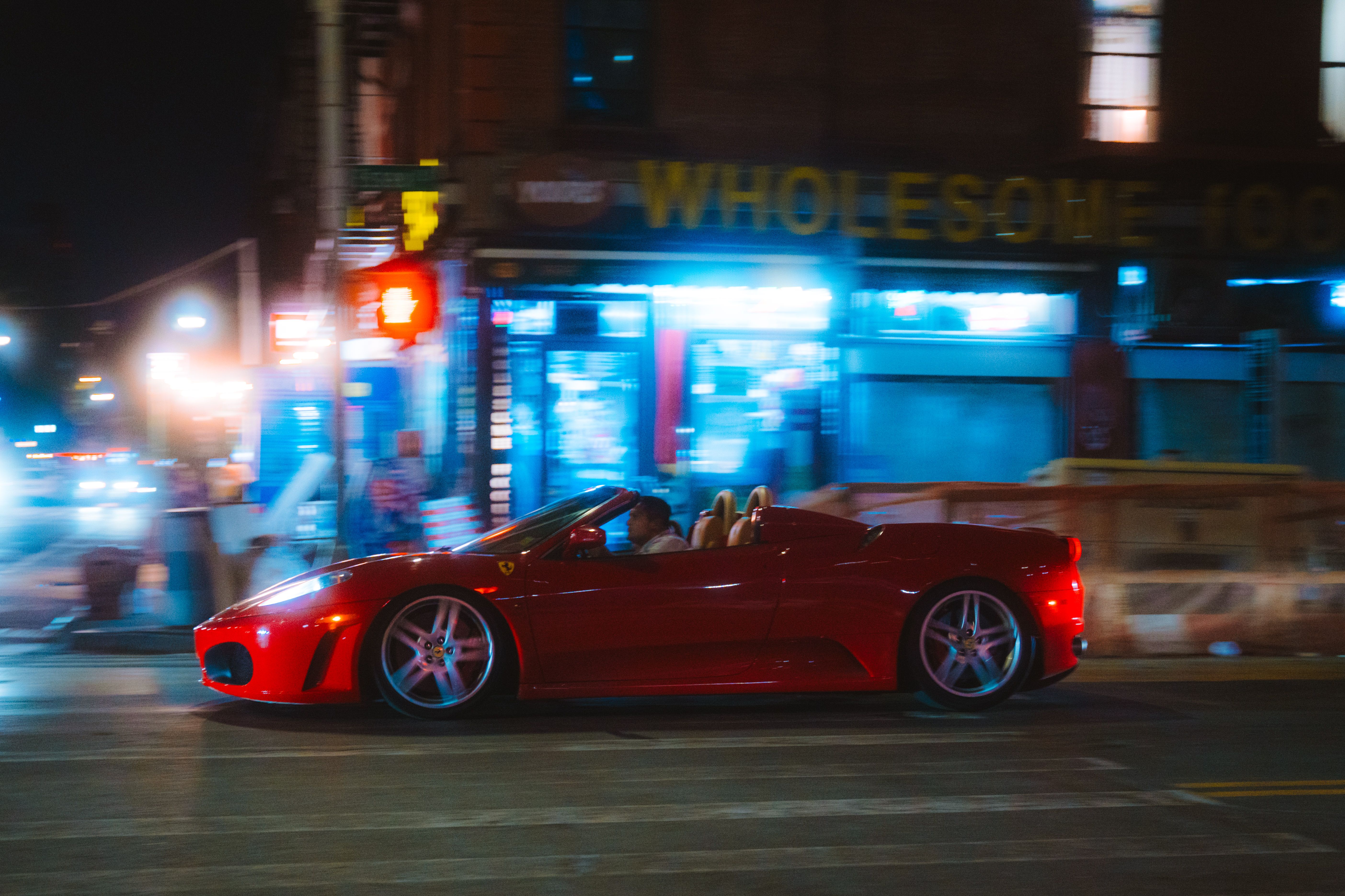 A Man Driving Red Convertible Car in the City at Night · Free Stock Photo