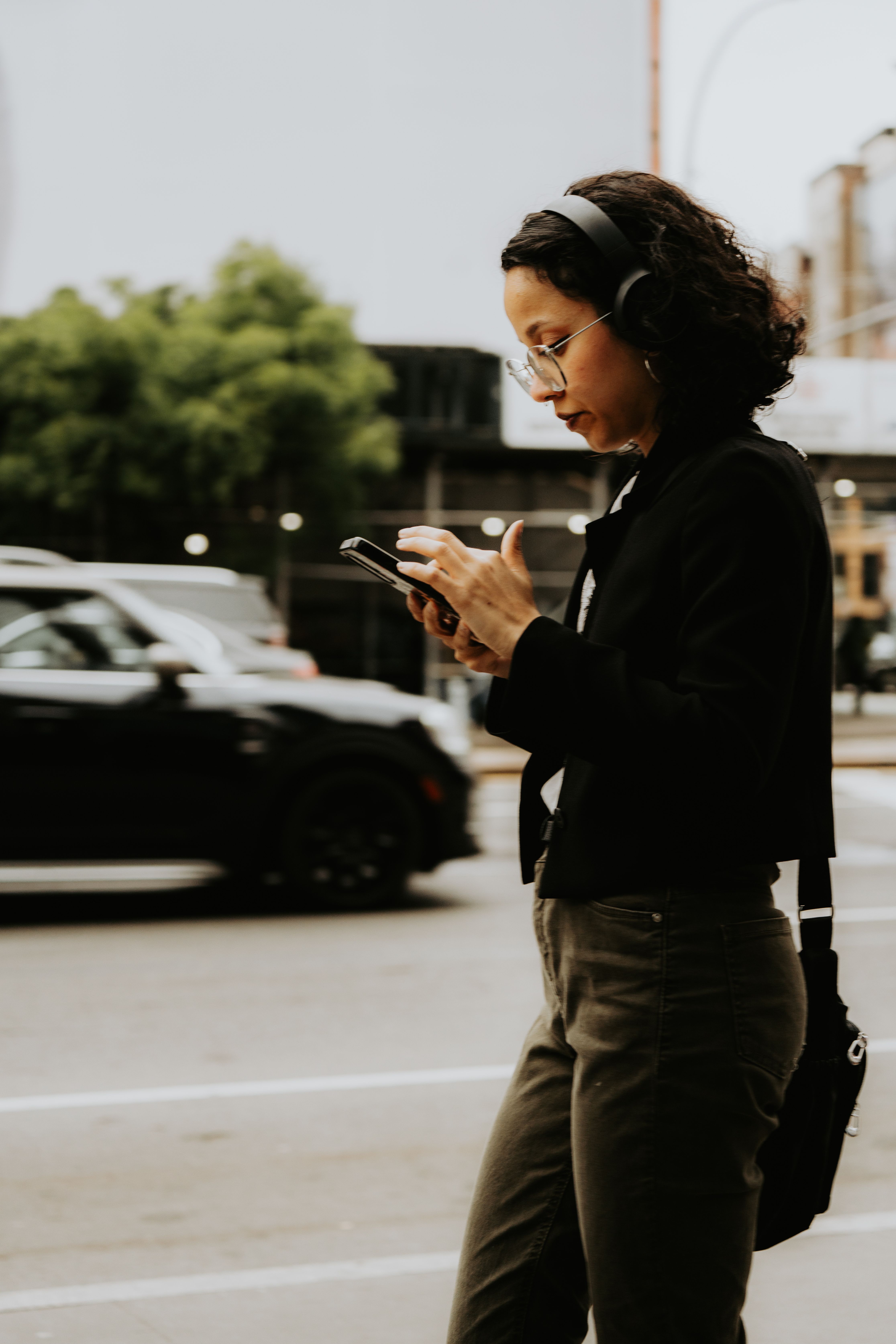 Woman Walking with Smartphone on Street · Free Stock Photo