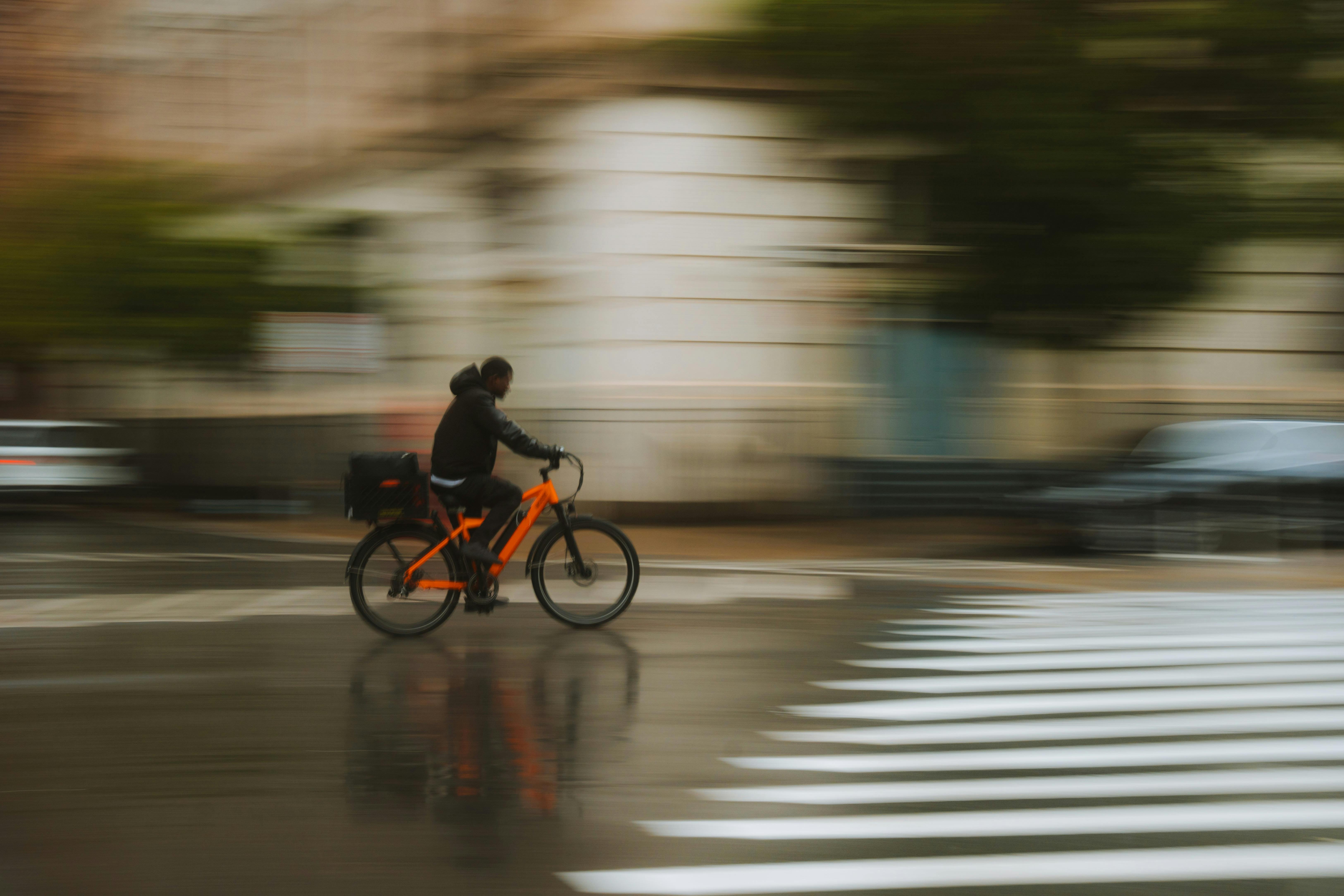 Person Riding a Bicycle during Rainy Day · Free Stock Photo