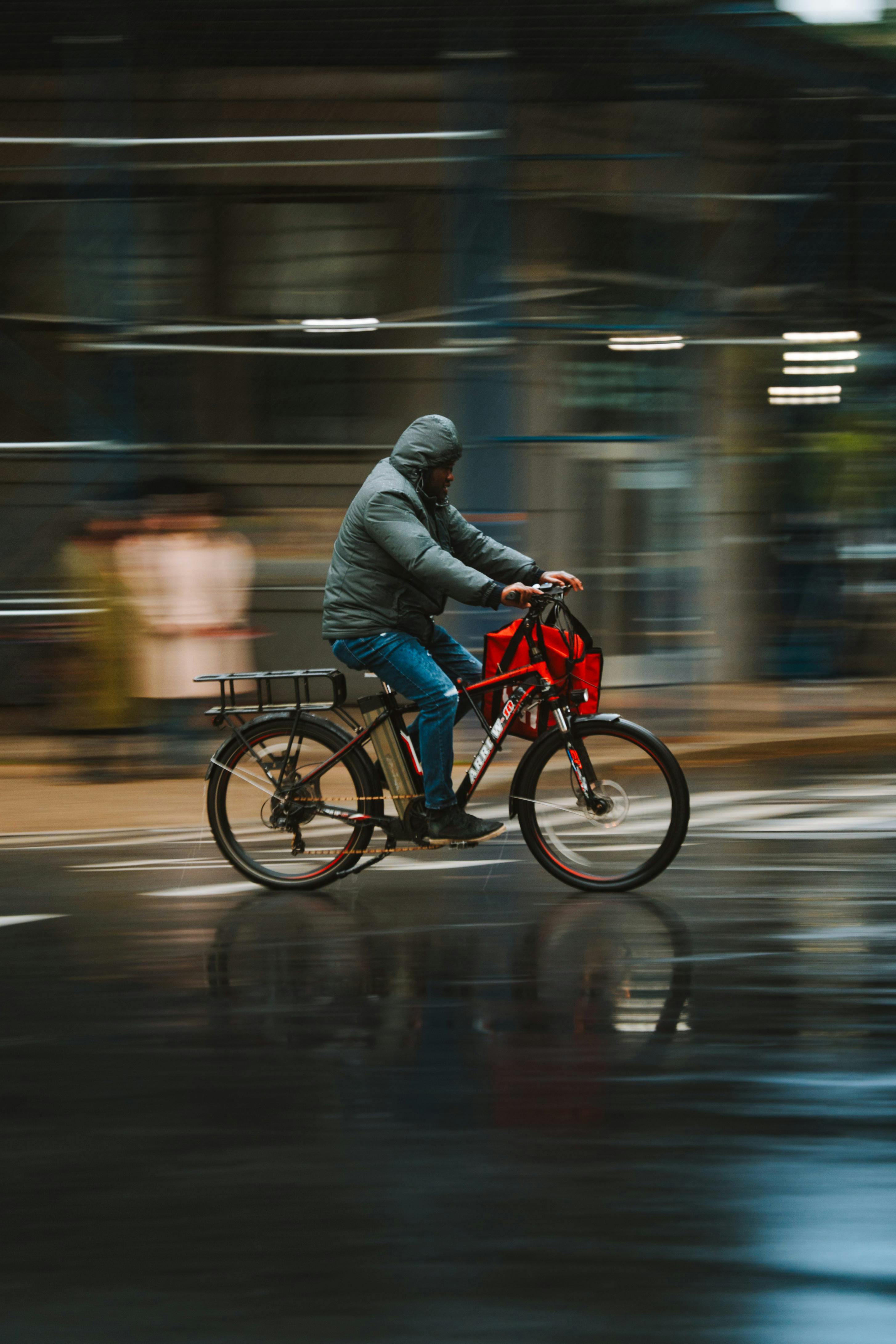 Person Riding a Bicycle during Rainy Day · Free Stock Photo