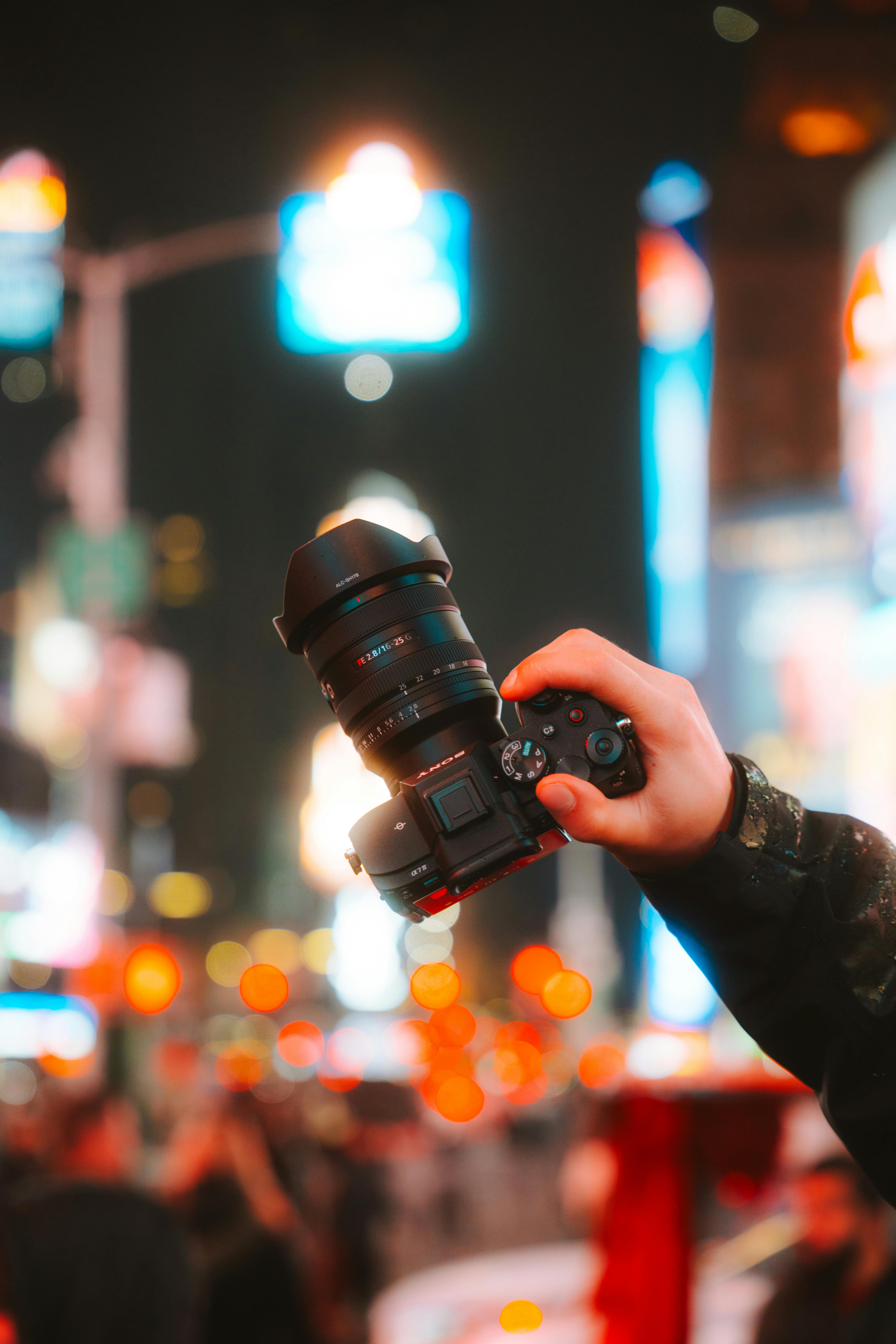 Man Hand Holding Camera at Night · Free Stock Photo