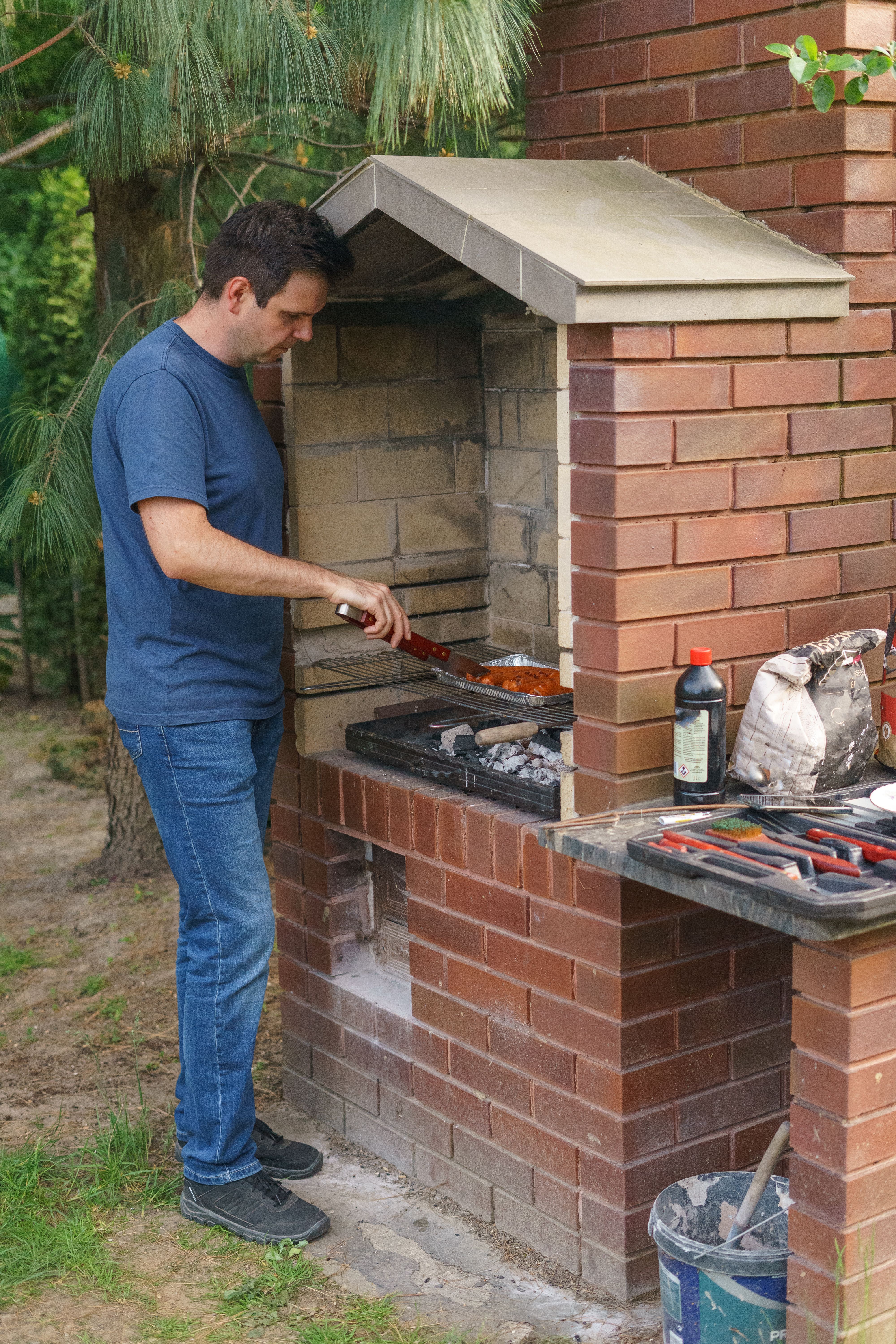 A Man Standing by a Barbecue Grill · Free Stock Photo